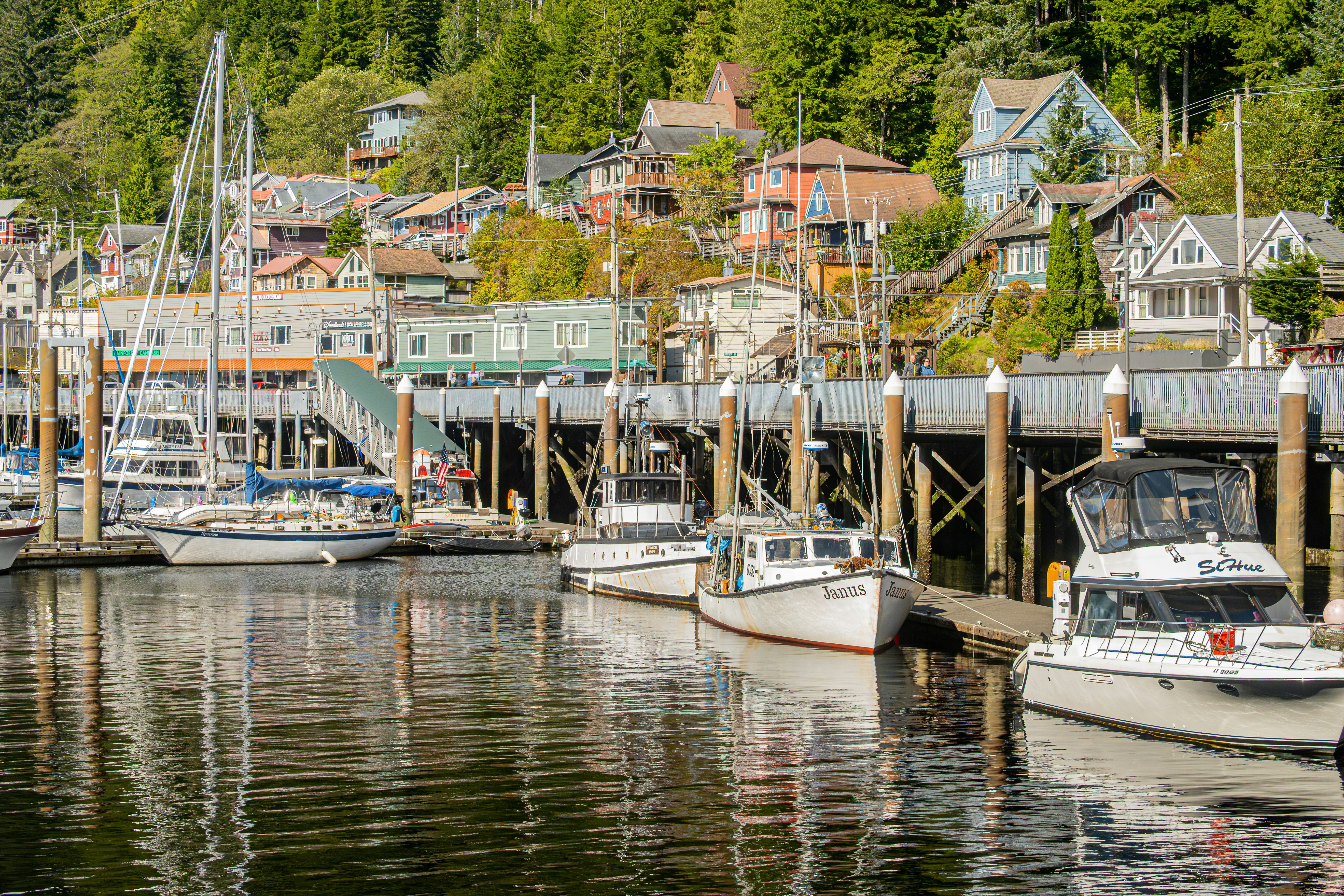 Harbor Rows: Boats Lined Along a Wooden Pier in a Quieter Waterfront Village