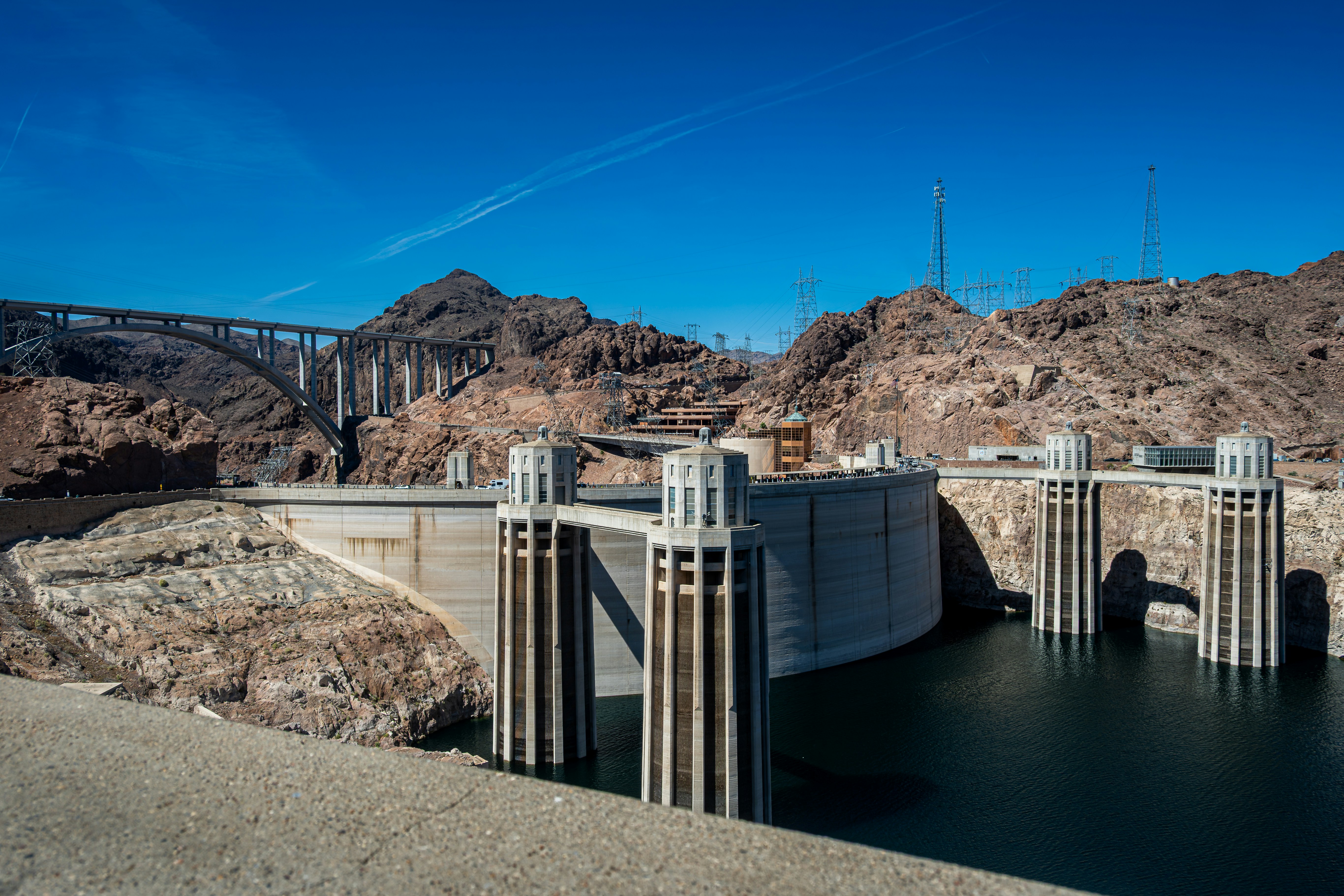 Concrete Guardians: A Dam Bridge Framing Desert Valleys Under a Clear Sky