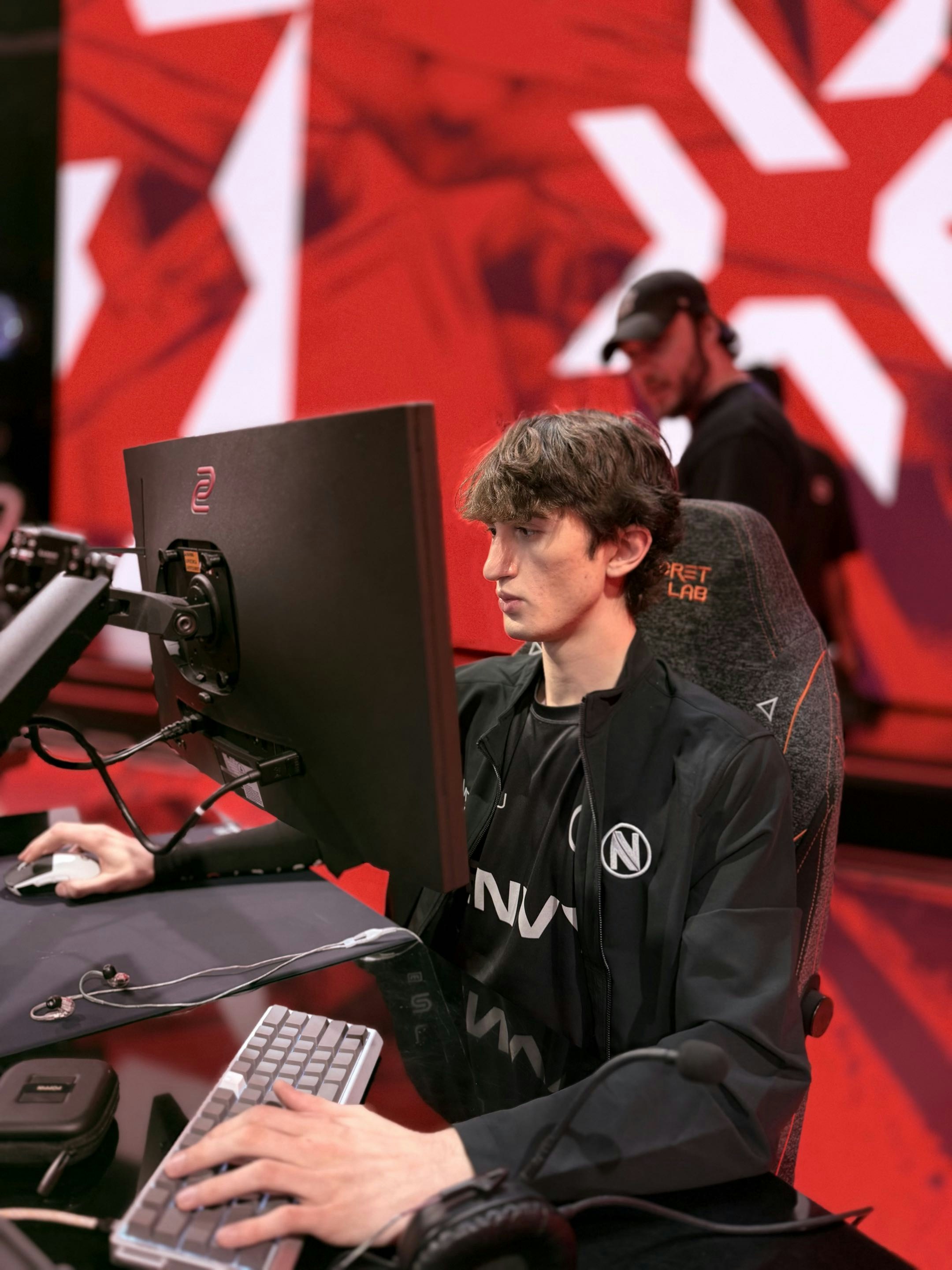 Focused Grit: Gamer at the Helm of a Neon Stage
