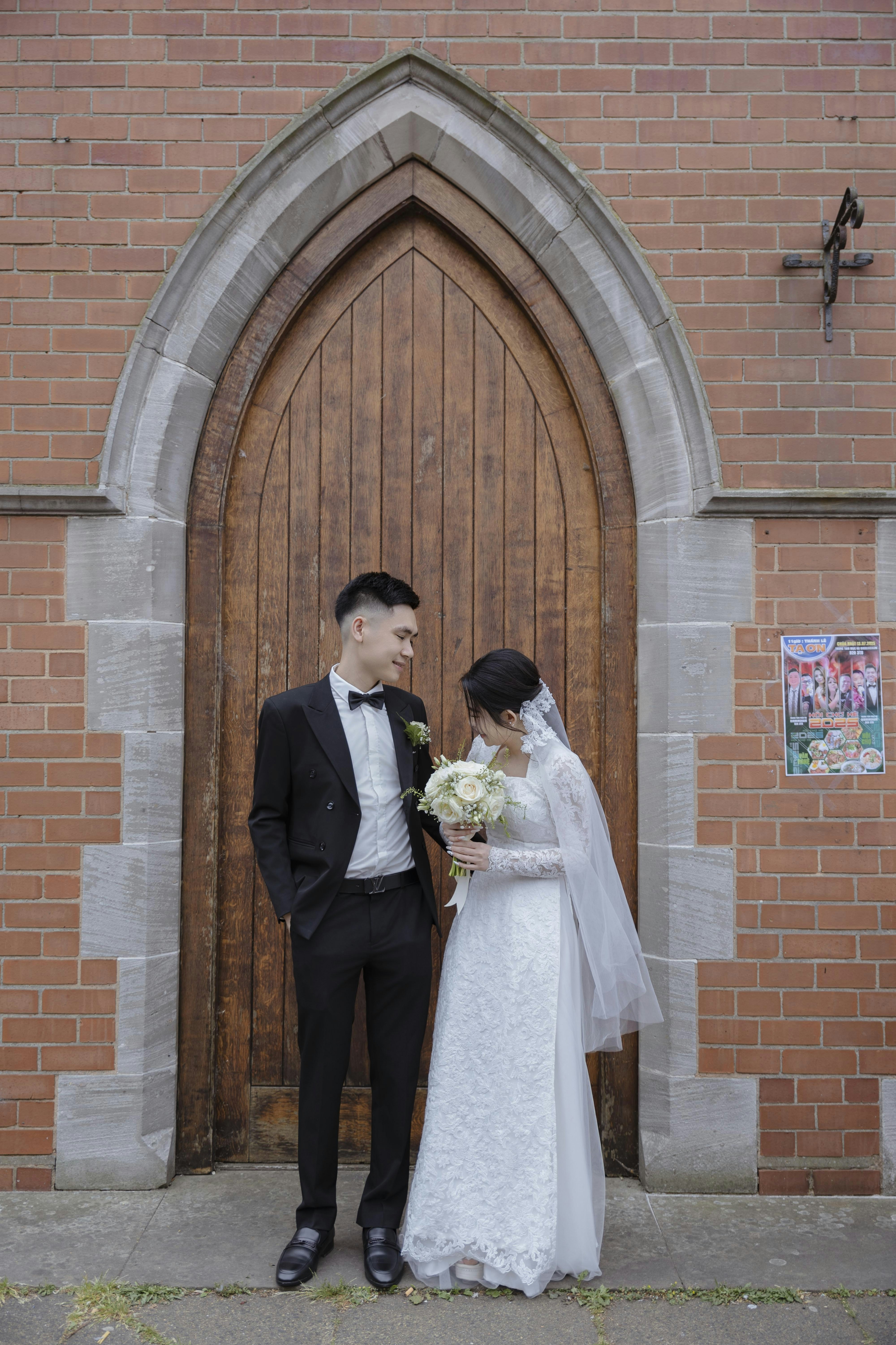 Vows at the Arched Threshold: A Quiet Moment Before the Walk Down the Aisle