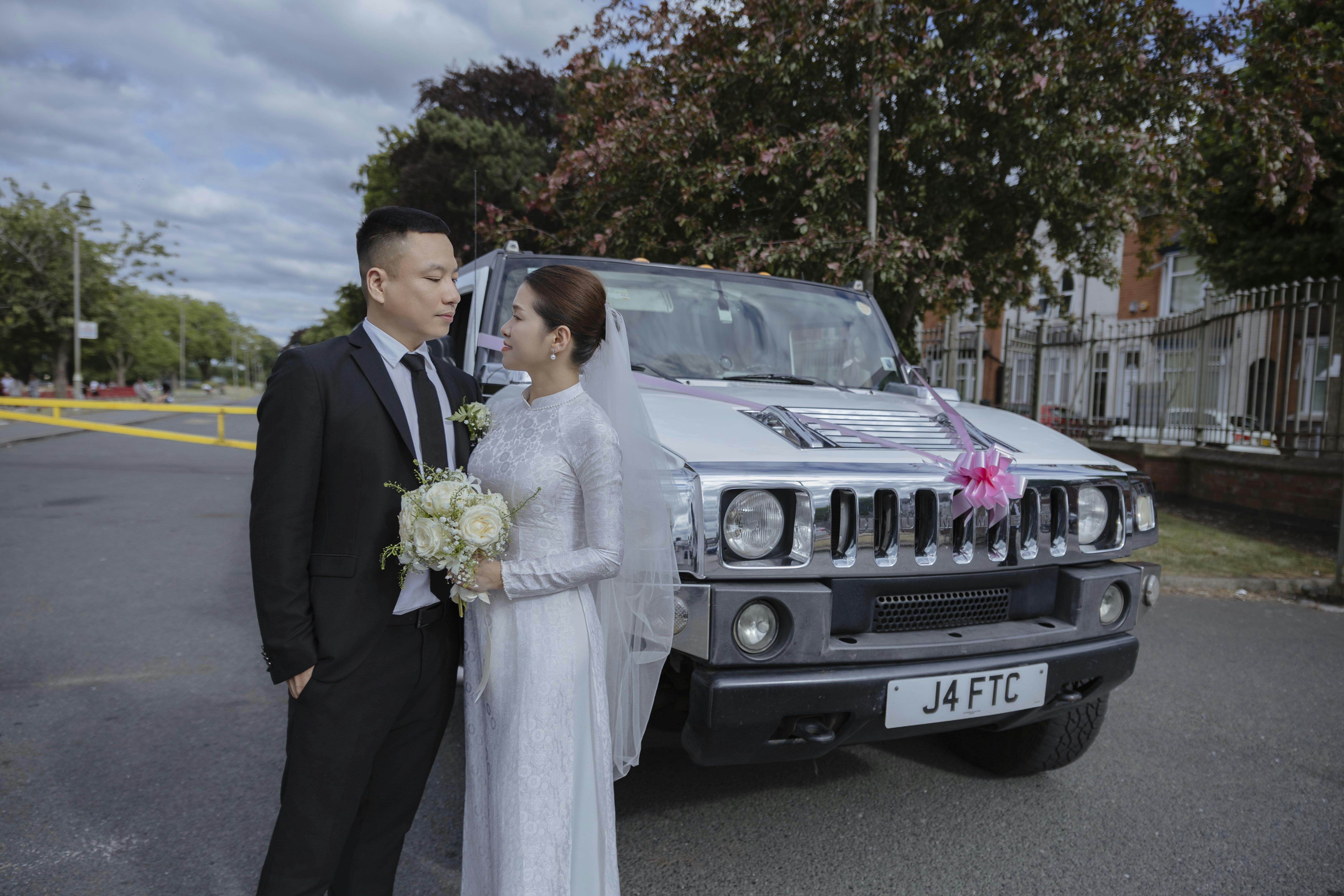 Bridal Moment by the Front of a Groomsmen’s Vehicle