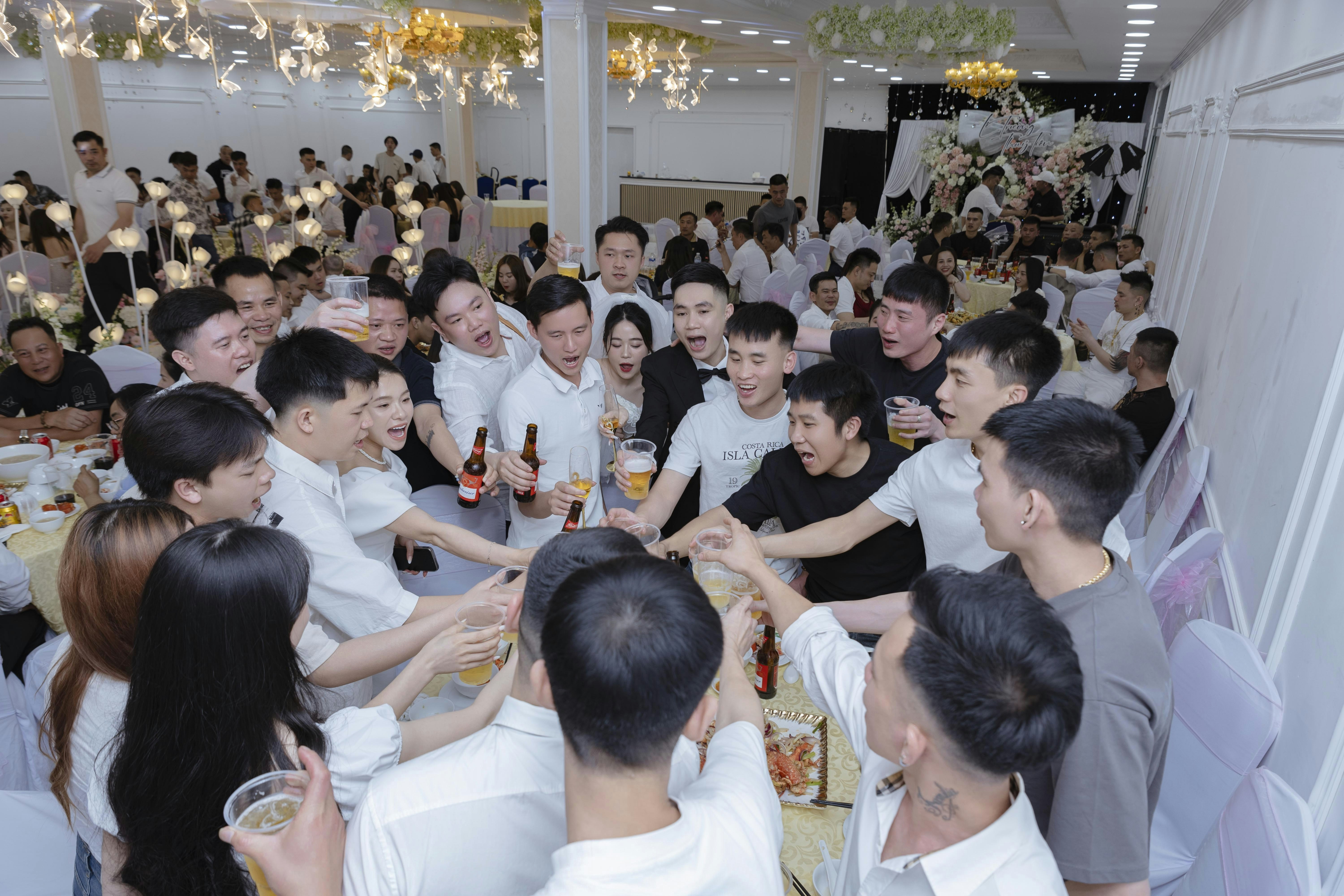 Group of friends toasting with drinks at a celebration.