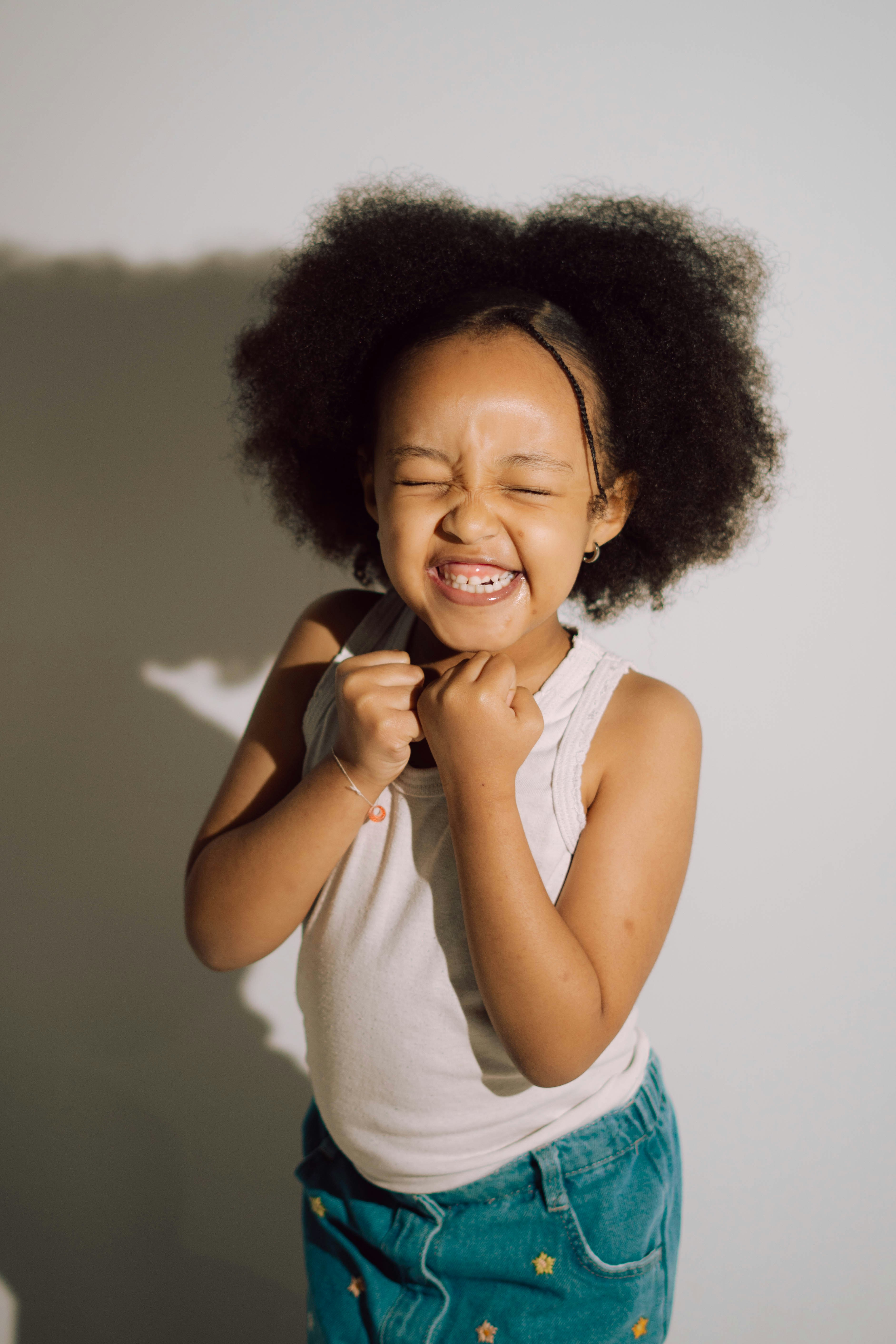 Joyful Burst: A Kid’s Grin and Hair Framing Light