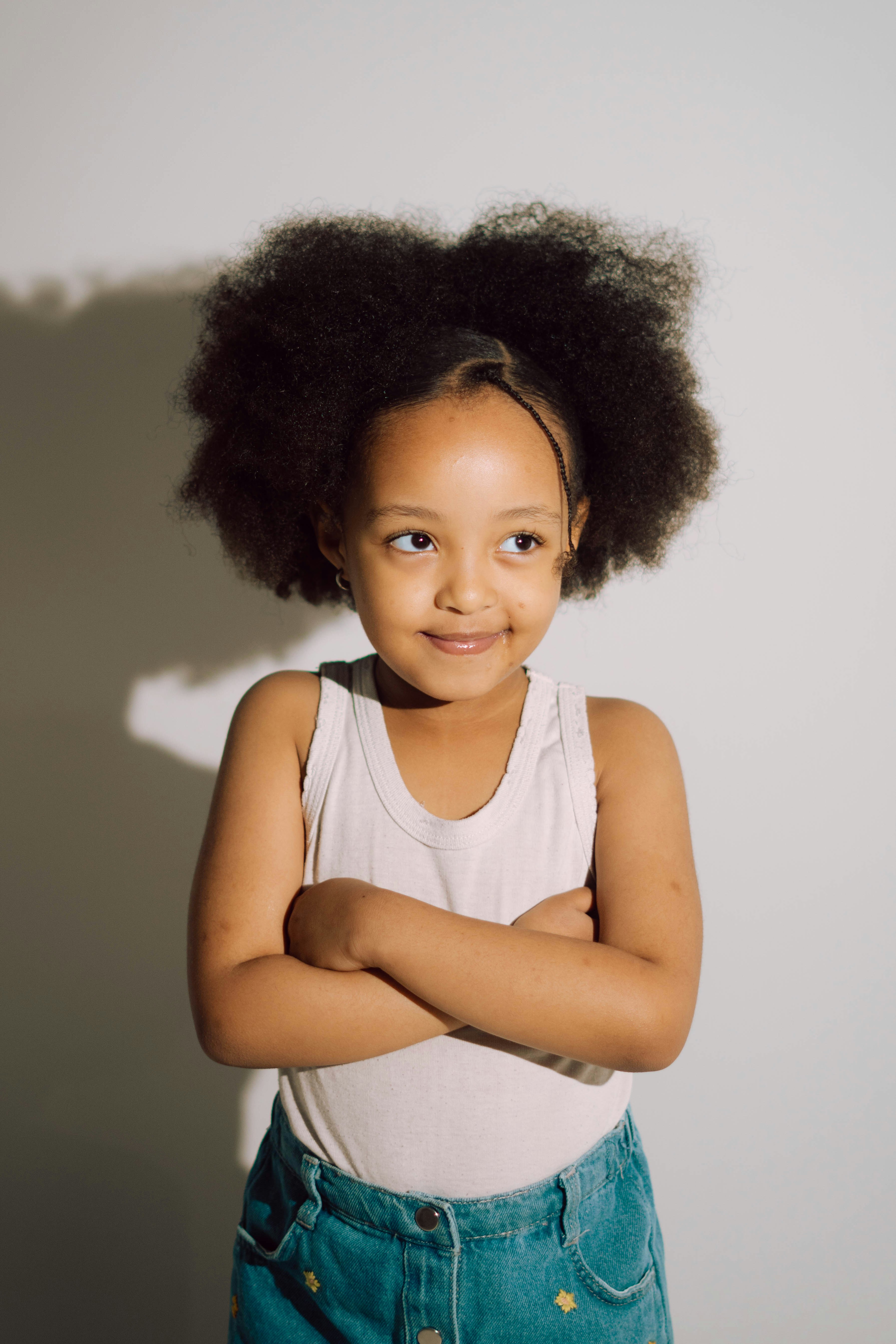 Curly Crown: A Playful Portrait with Sunny Confidence