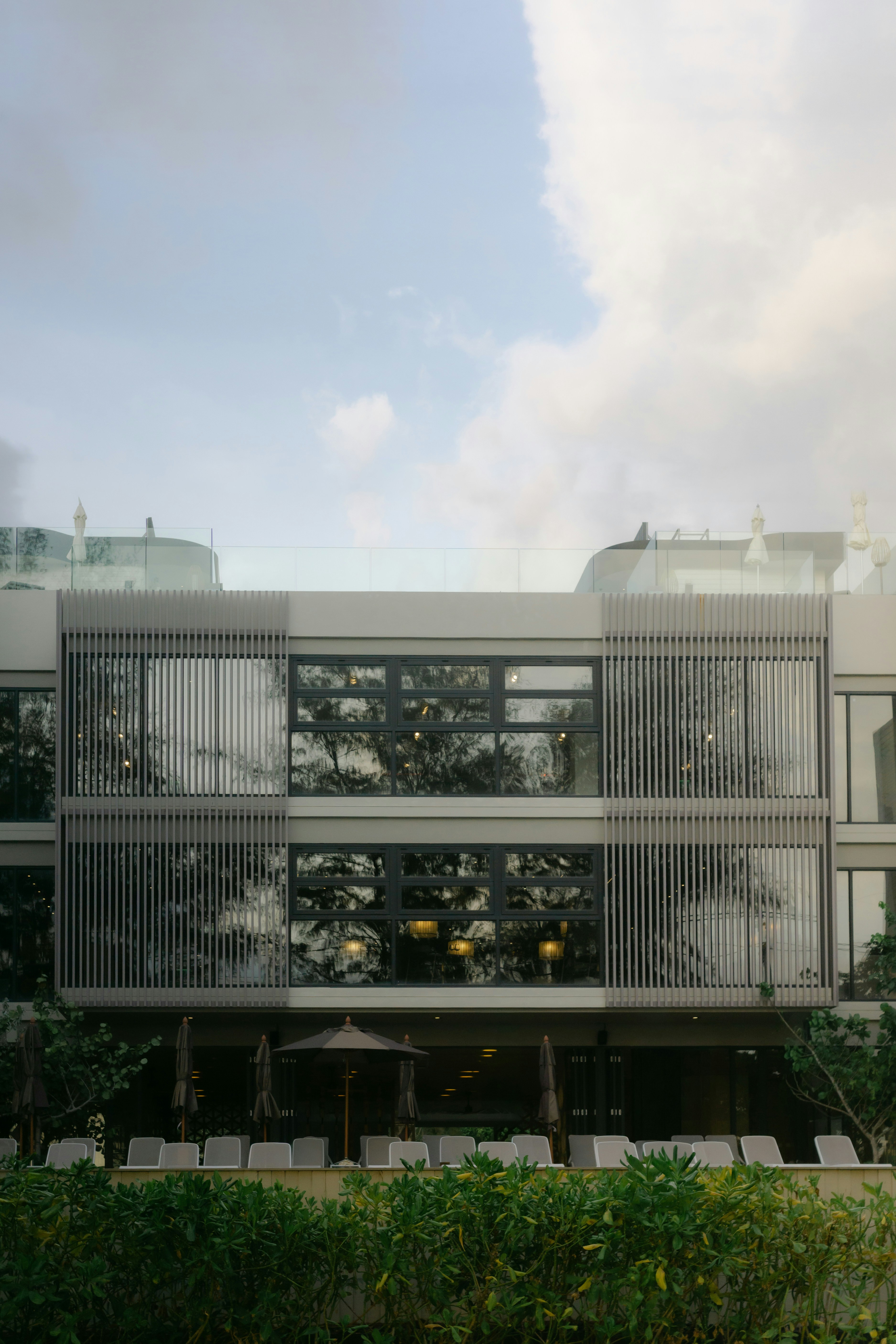Modern Glass Facade Meets Green Terrace