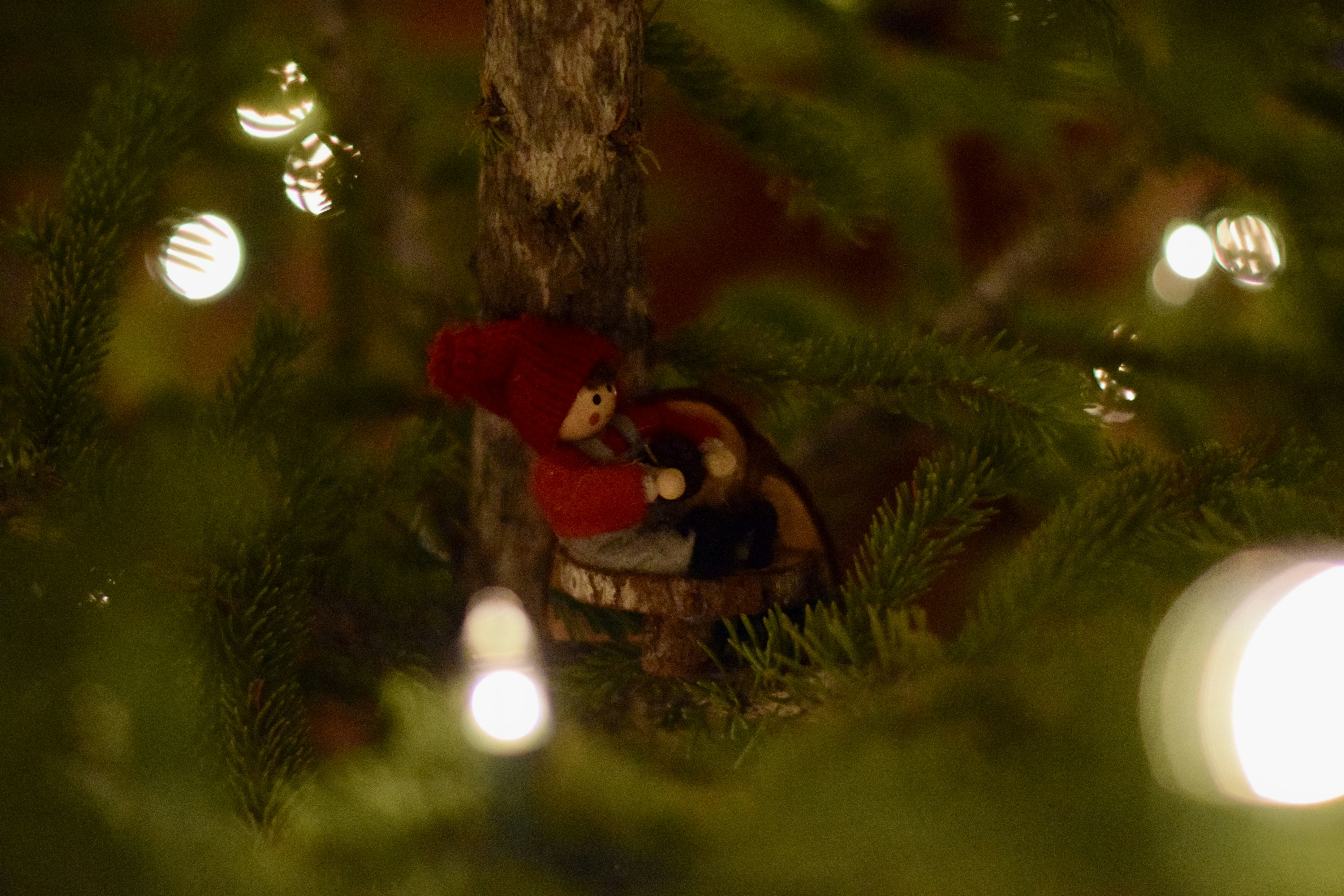 Tiny Carved Figurines Nest in a Christmas Tree Nook