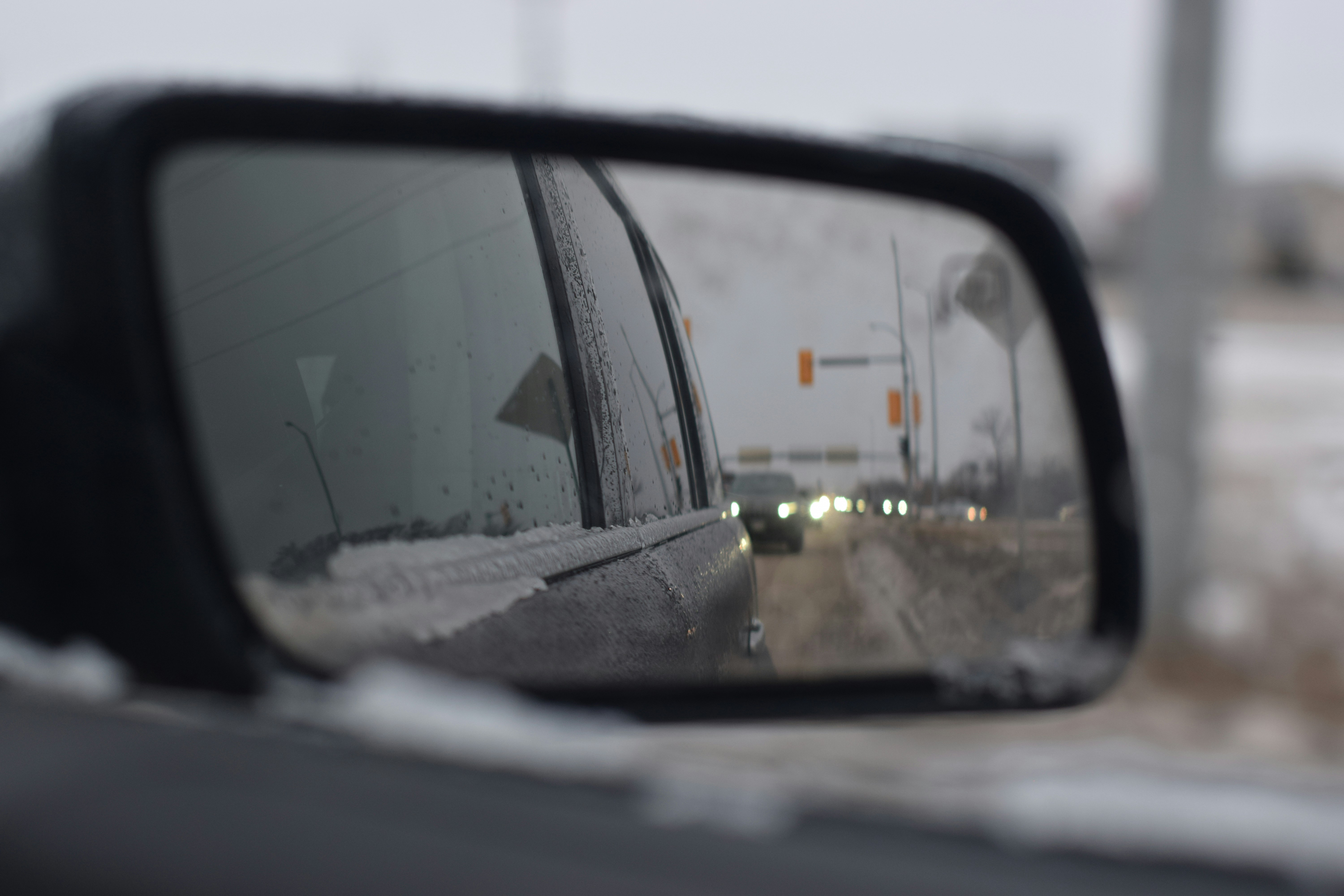 Rear-View Window Focus: Icy Street Reflections in a Side Mirror