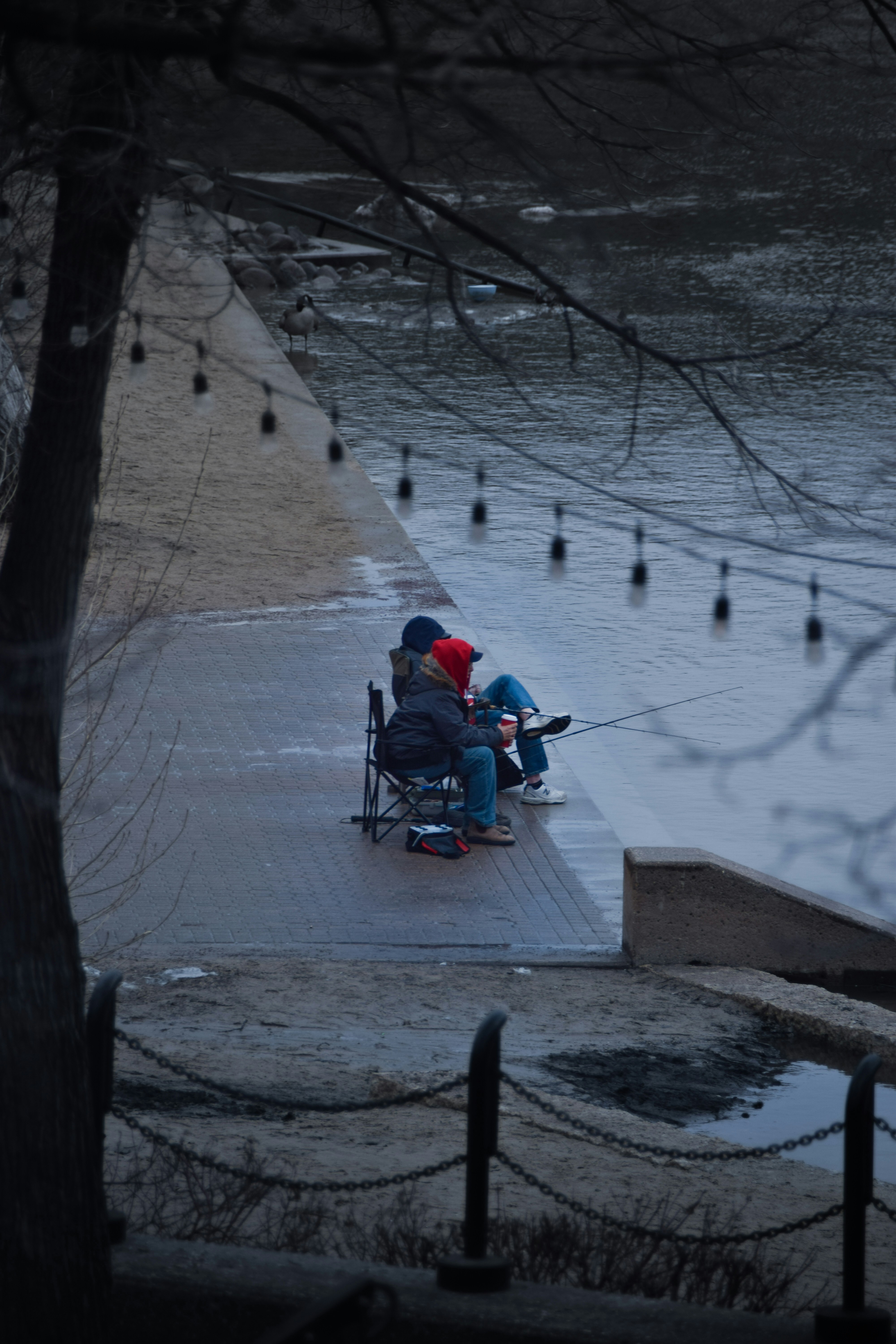 Evening by the Riverbank: Anglers and a Cone of Light