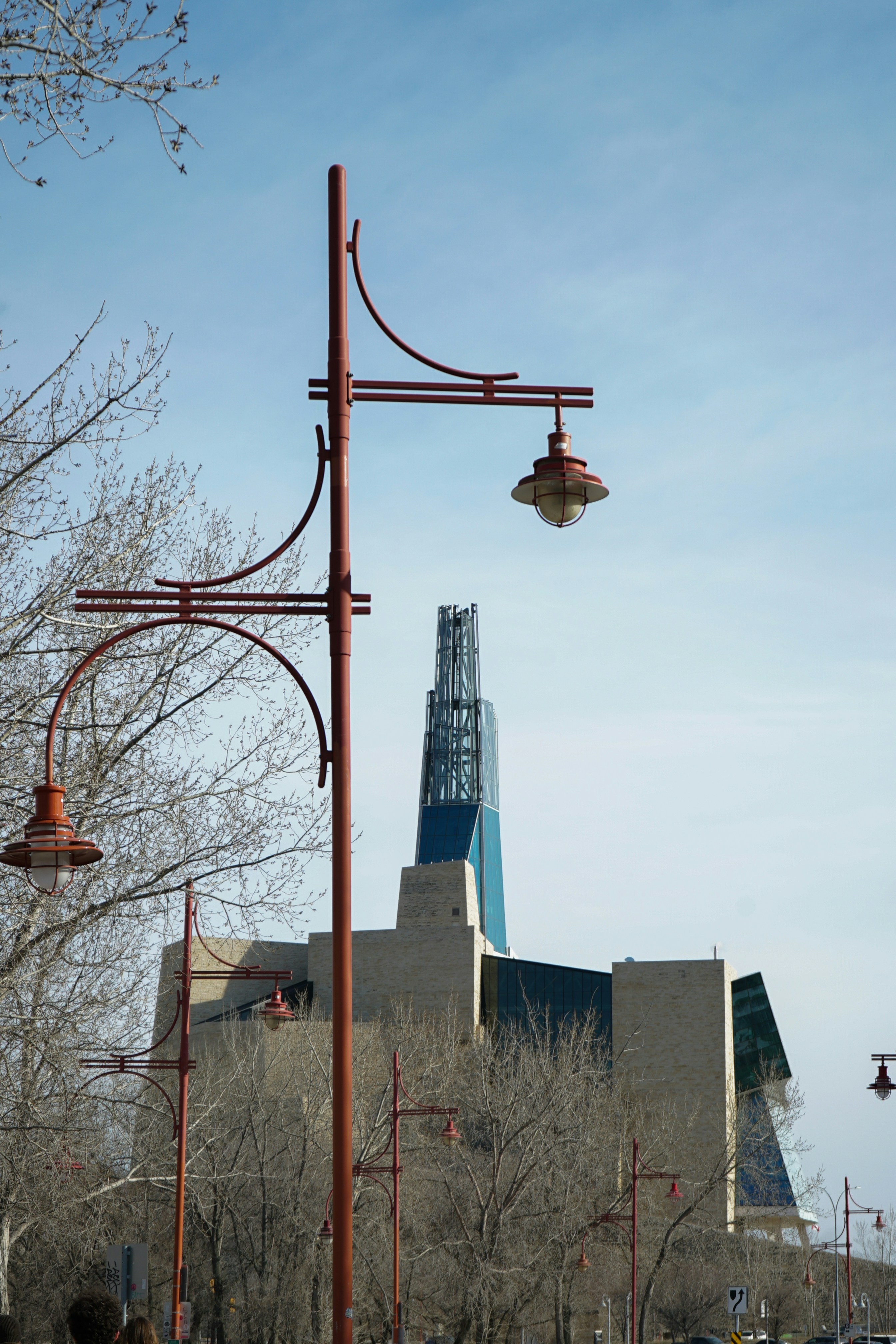 Red Lamp Posts and Modern Building: Urban Landscape under Clear Sky