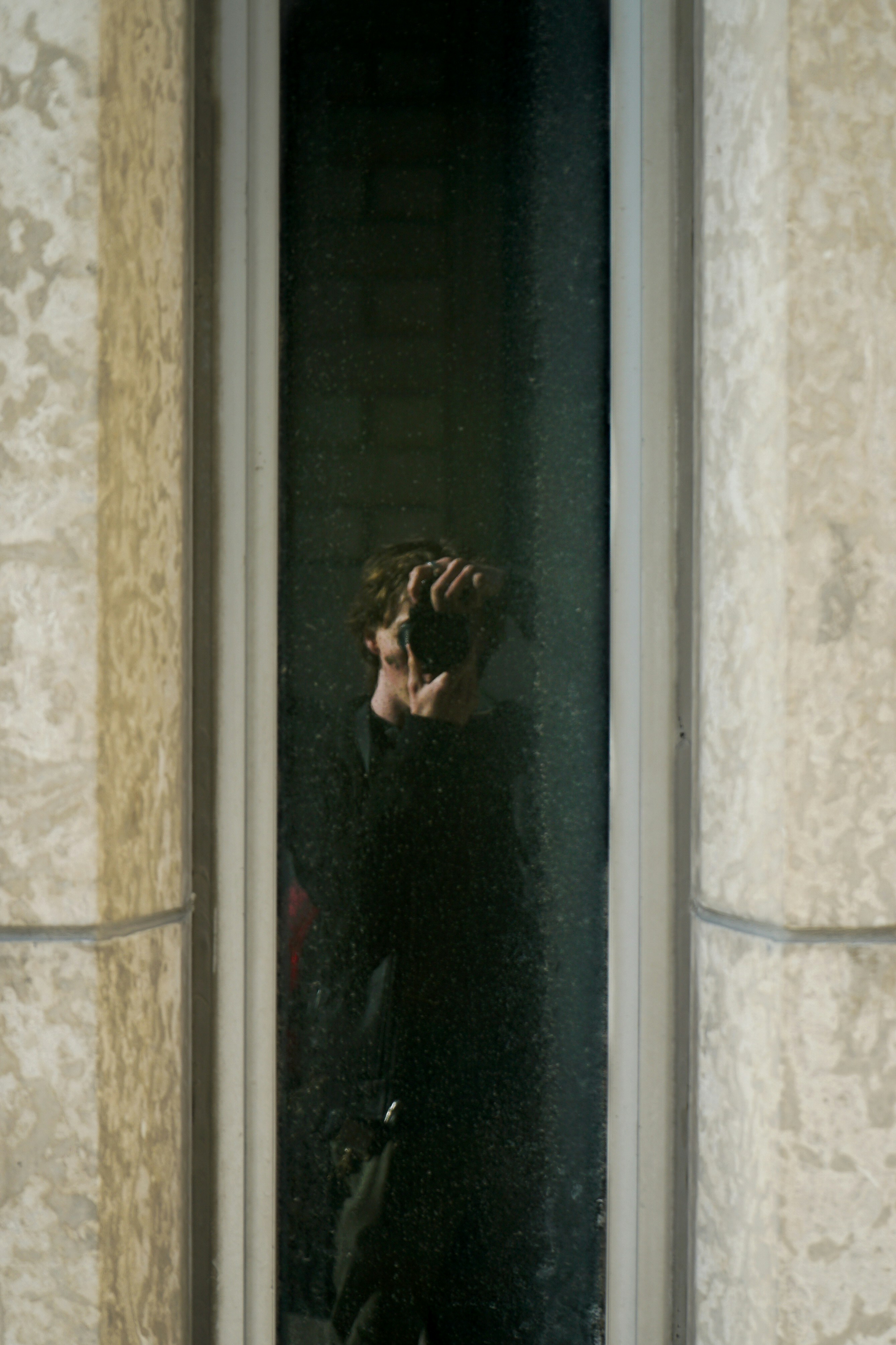 Reflected Moment: A Hidden Portrait in a Narrow Window