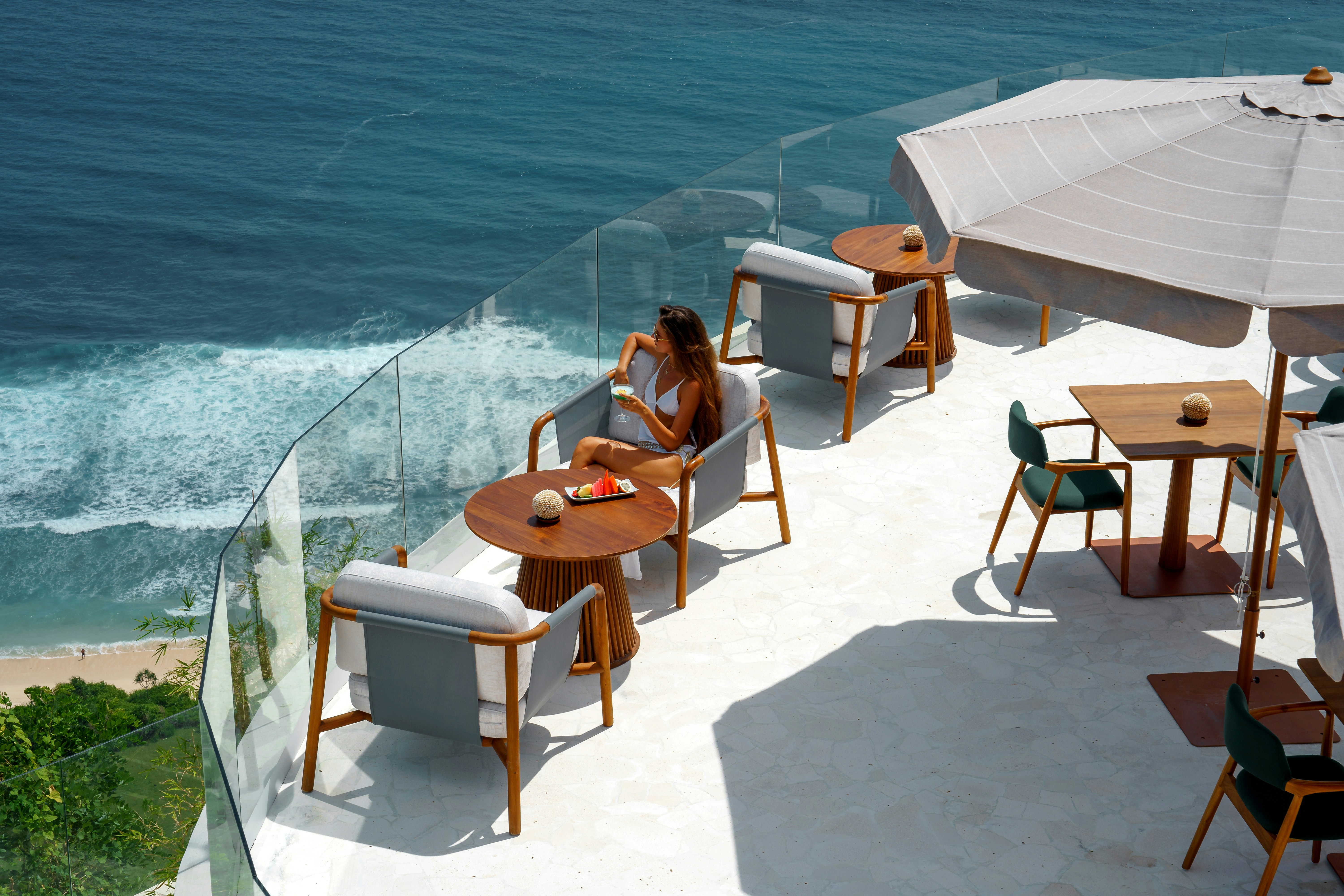 Lavish Seaside Café: Sunlit Tables Along a Glass Balcony