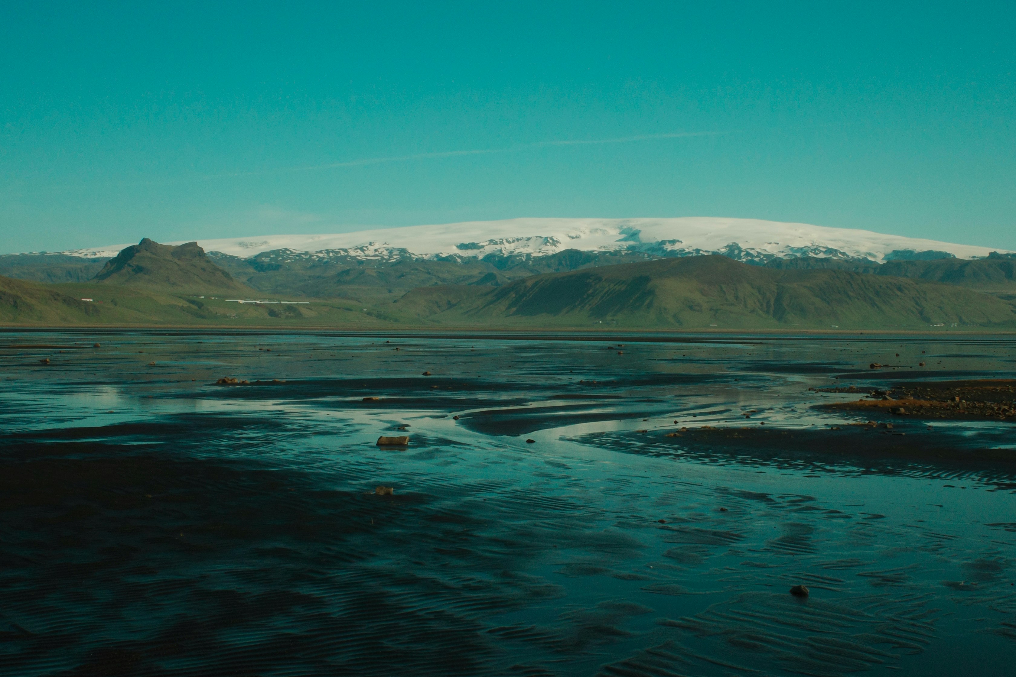 Snow-capped mountain range under a clear blue sky.