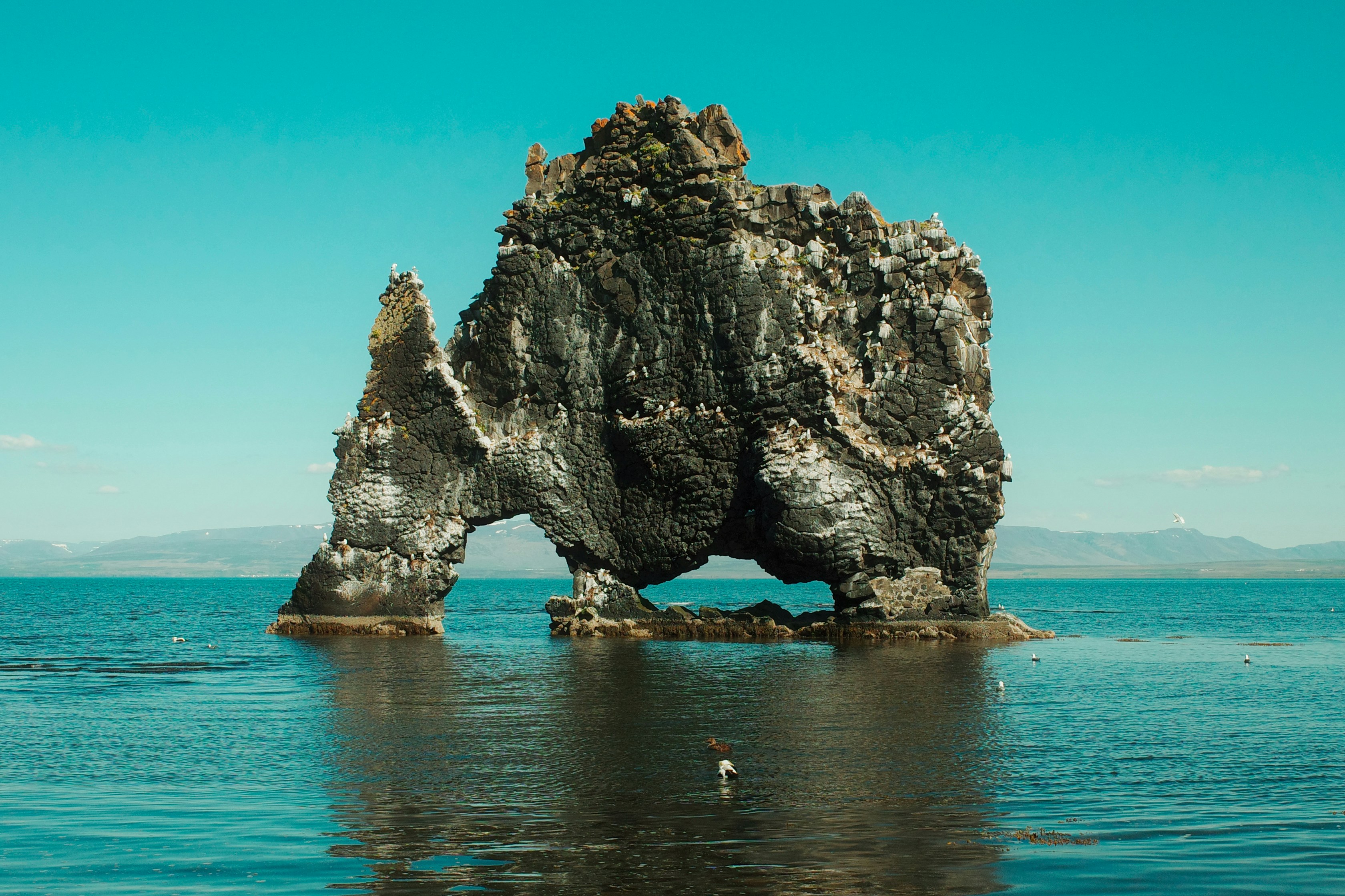 Sea Arch Monolith: A Lone Isle Dragon in Turquoise Water