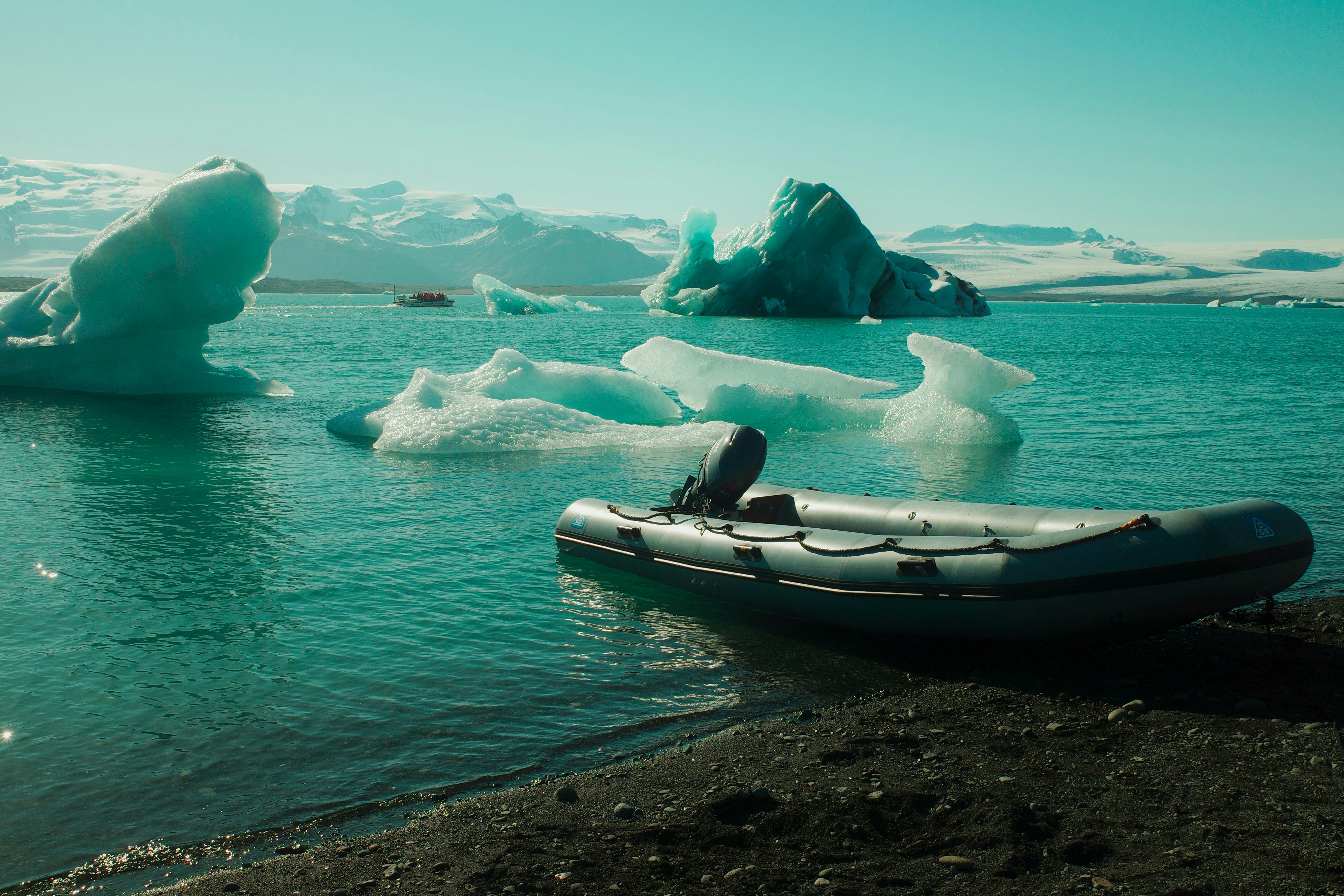 Iso-Blue Drift: A Rigid Inflatable near Icebergs Under A Pale Sky