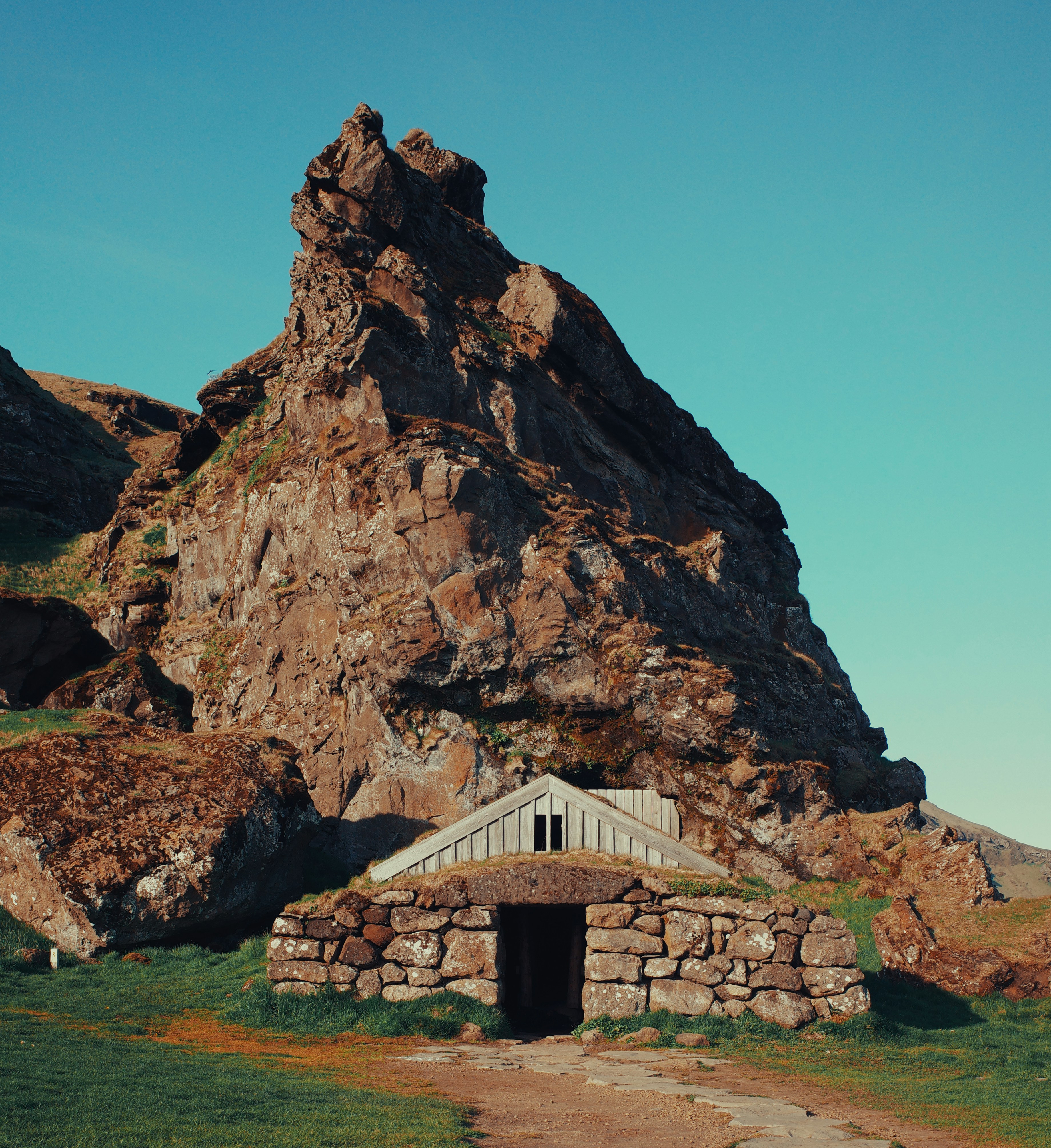 Stone Shelter at the Foot of a Monumental Peak