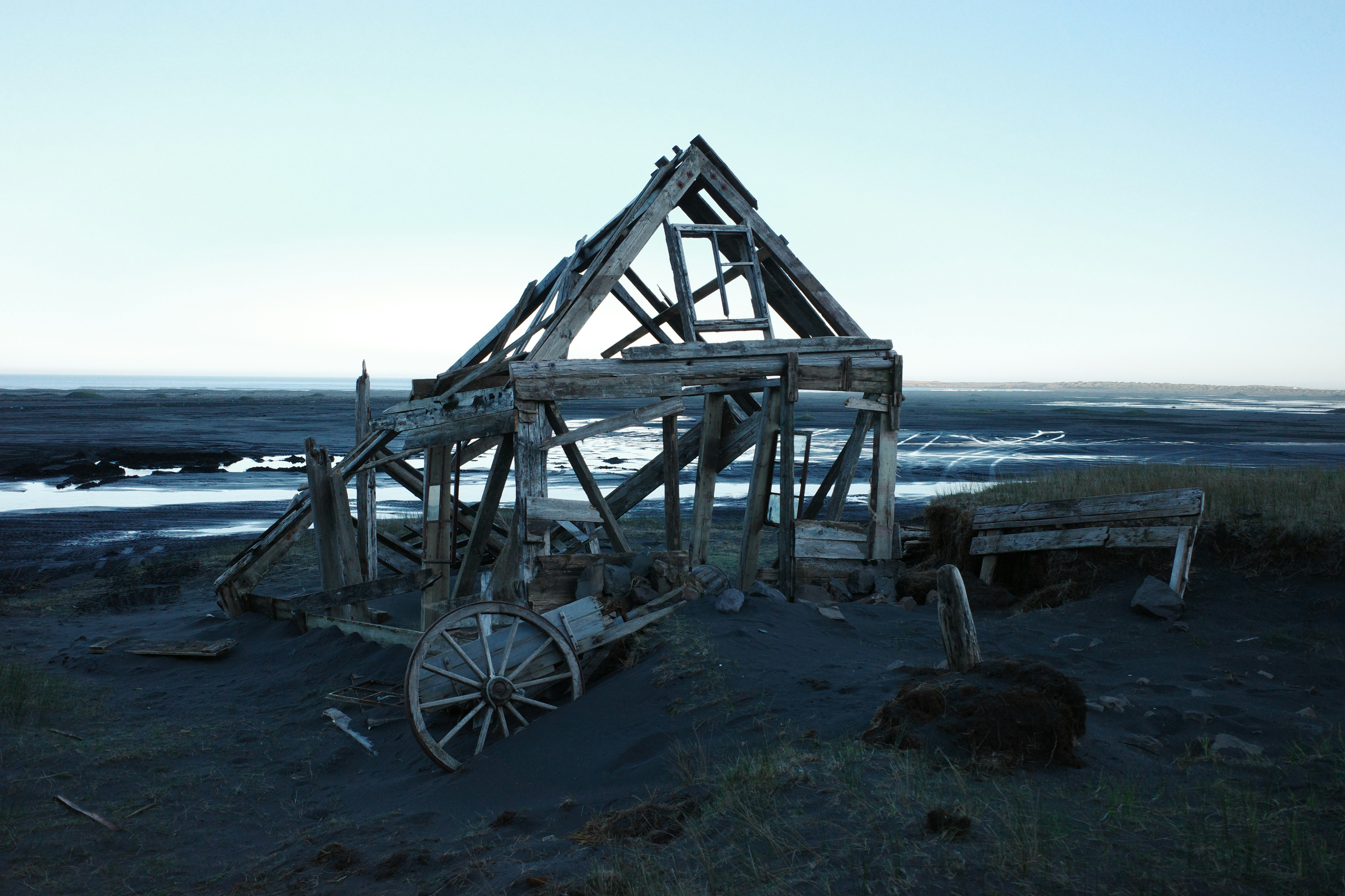Decay on the Dune Farm: A Weathered Wagon Resting in the Shoreline Ruins