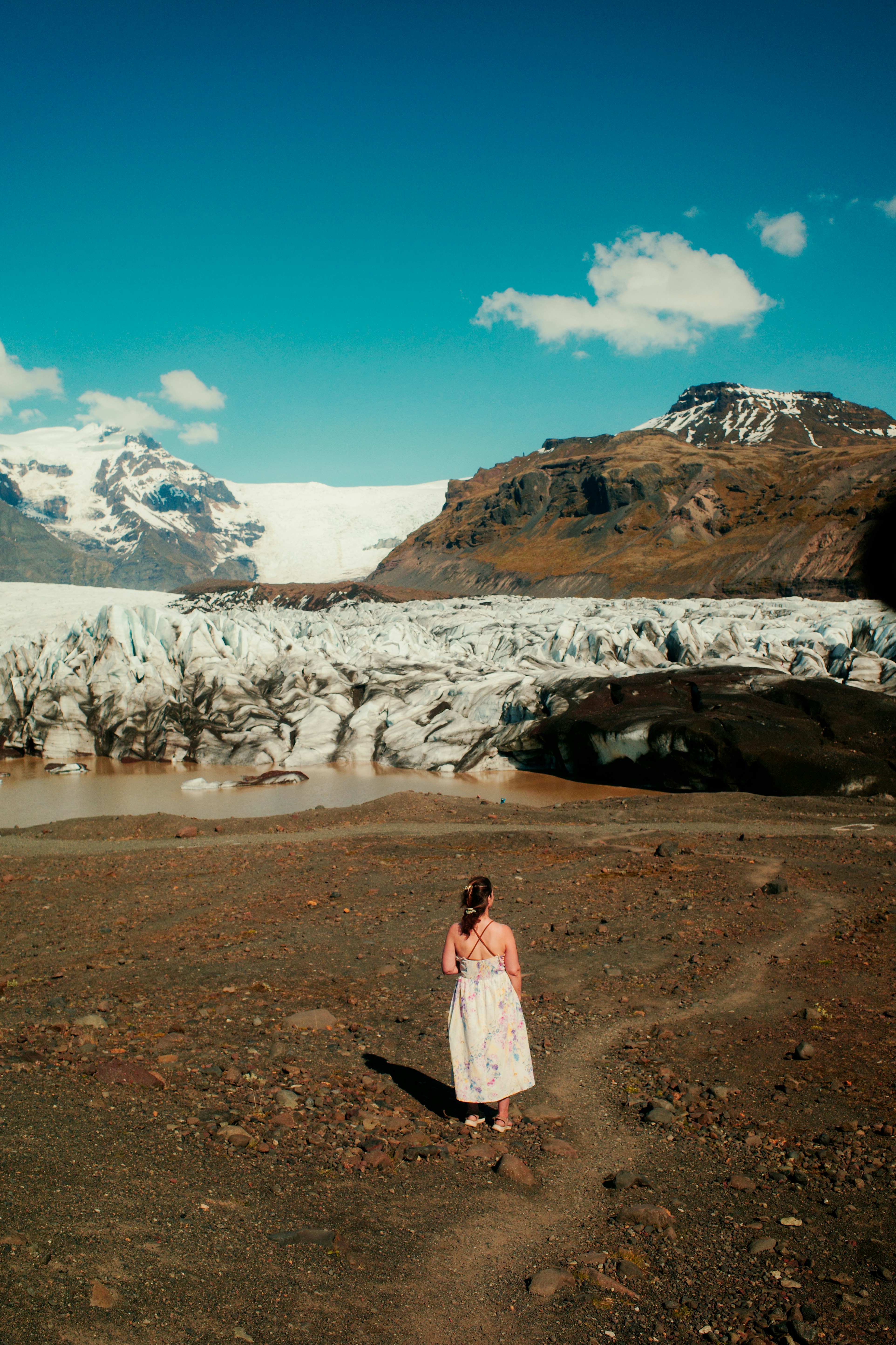 Footstep toward the Glacier: A lone traveler on a volcanic shoreline