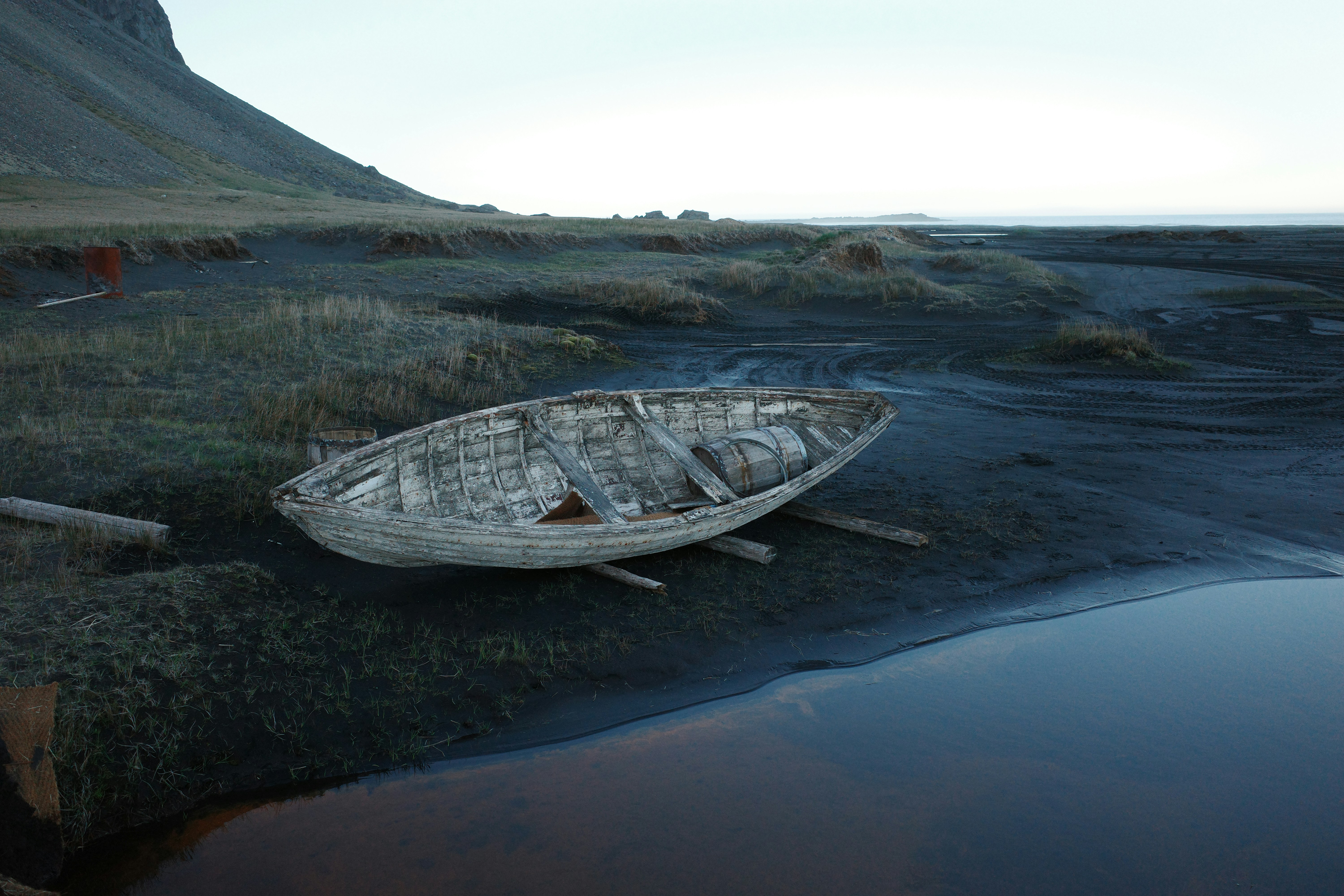 Driftwood Vessel Resting at the Tidal Edge