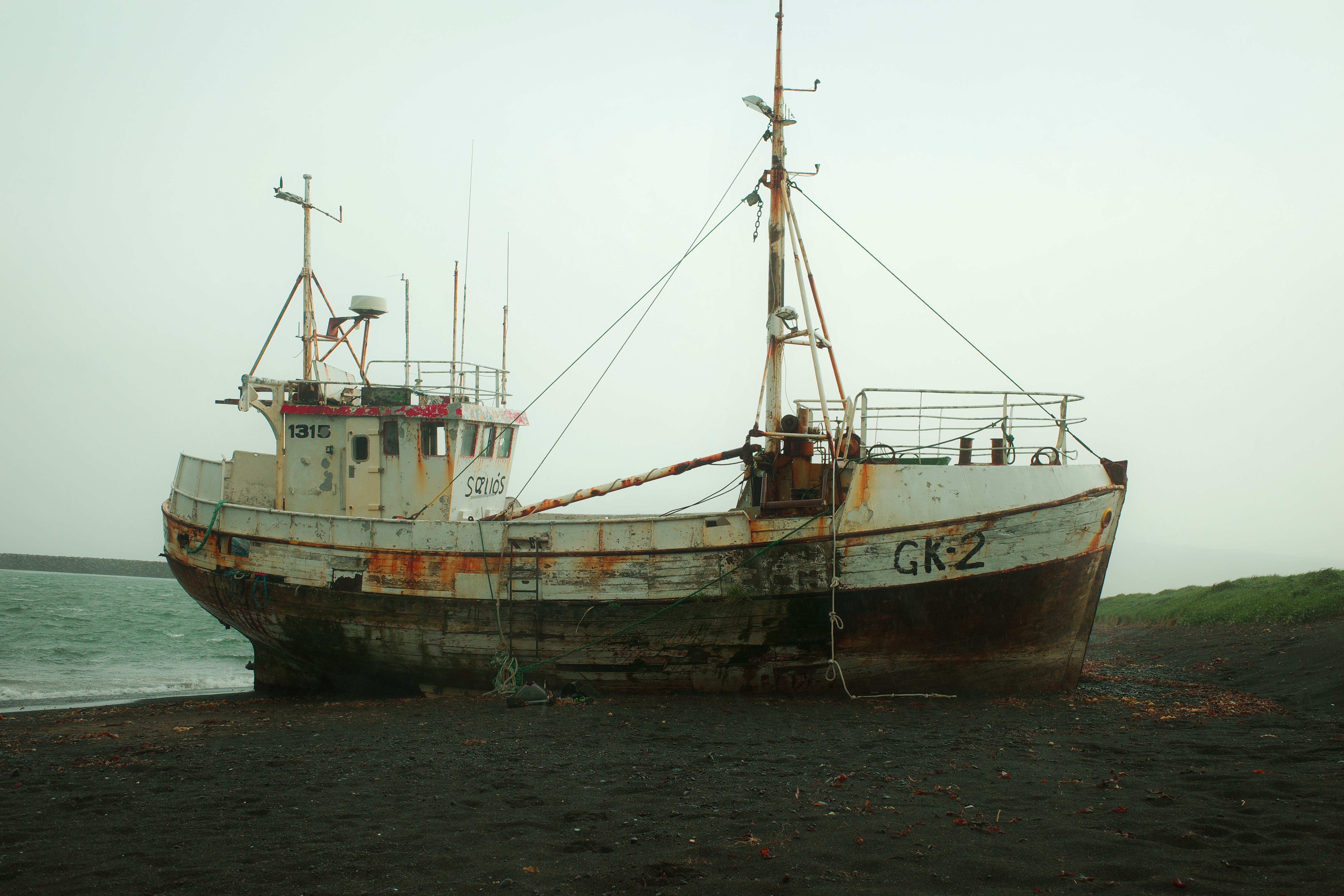 Rusting Vessel on a Charred Shore