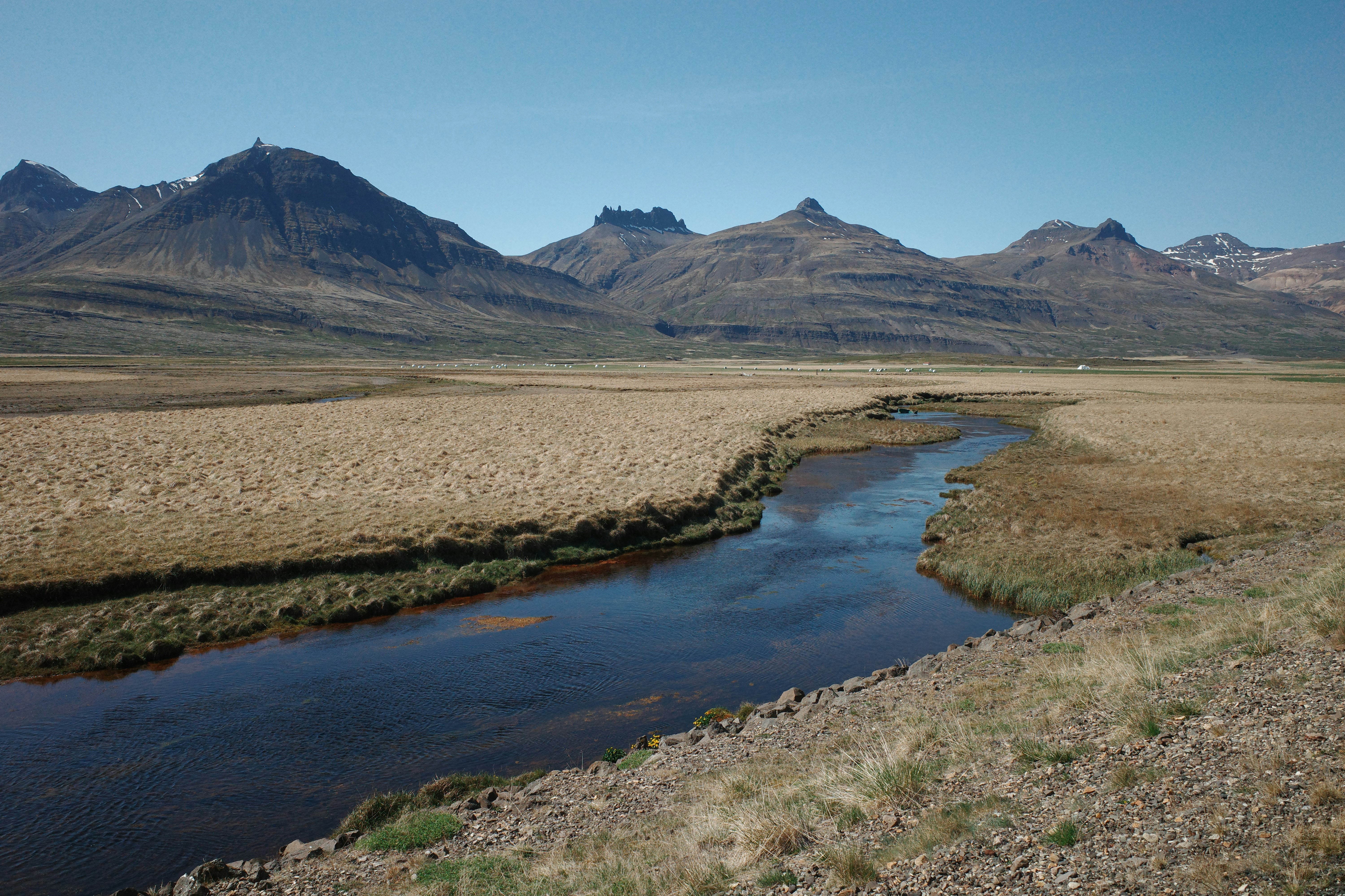 Desert Creek Winding Toward Silhouetted Peaks