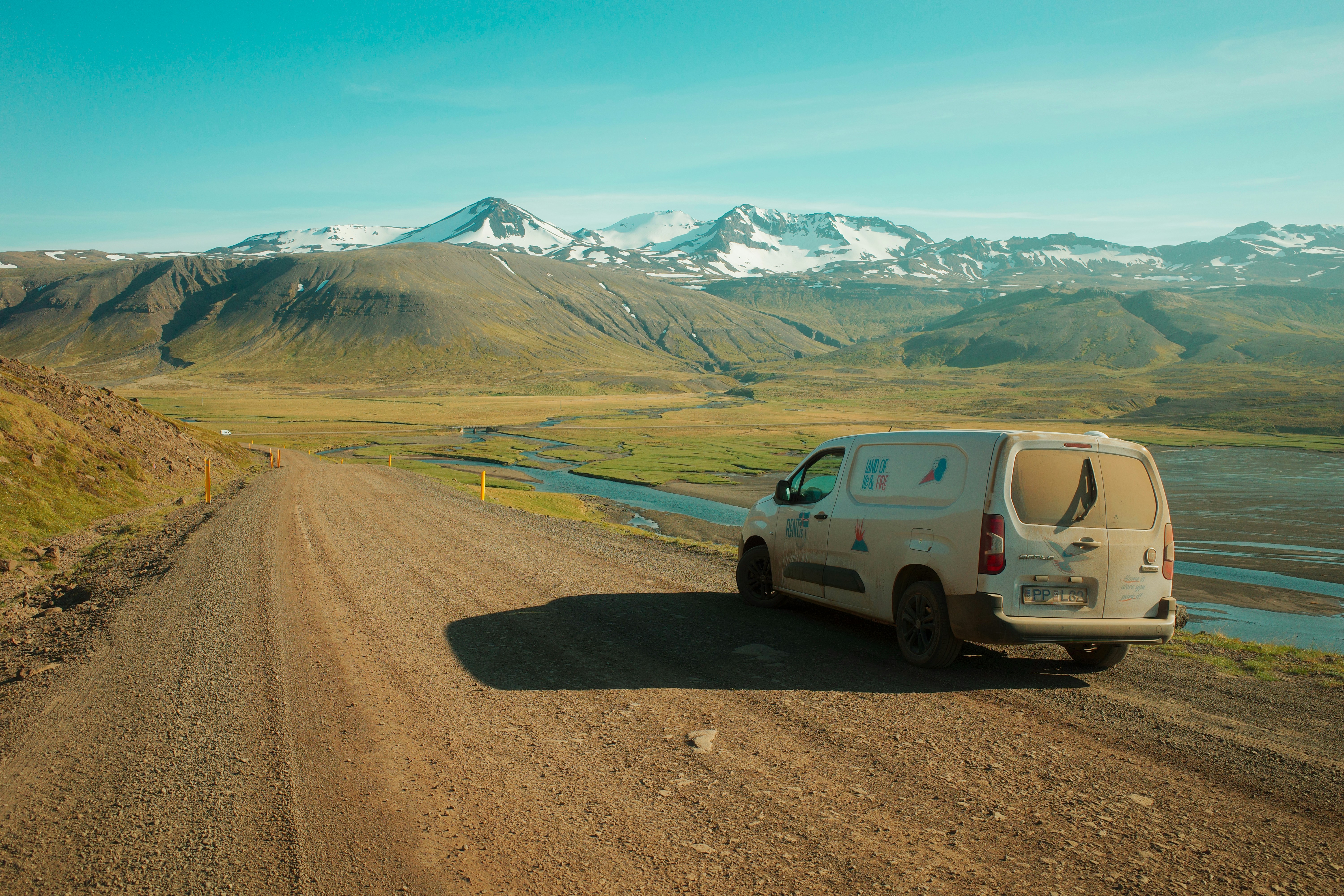 Vanishing Road to Snow-Capped Peaks