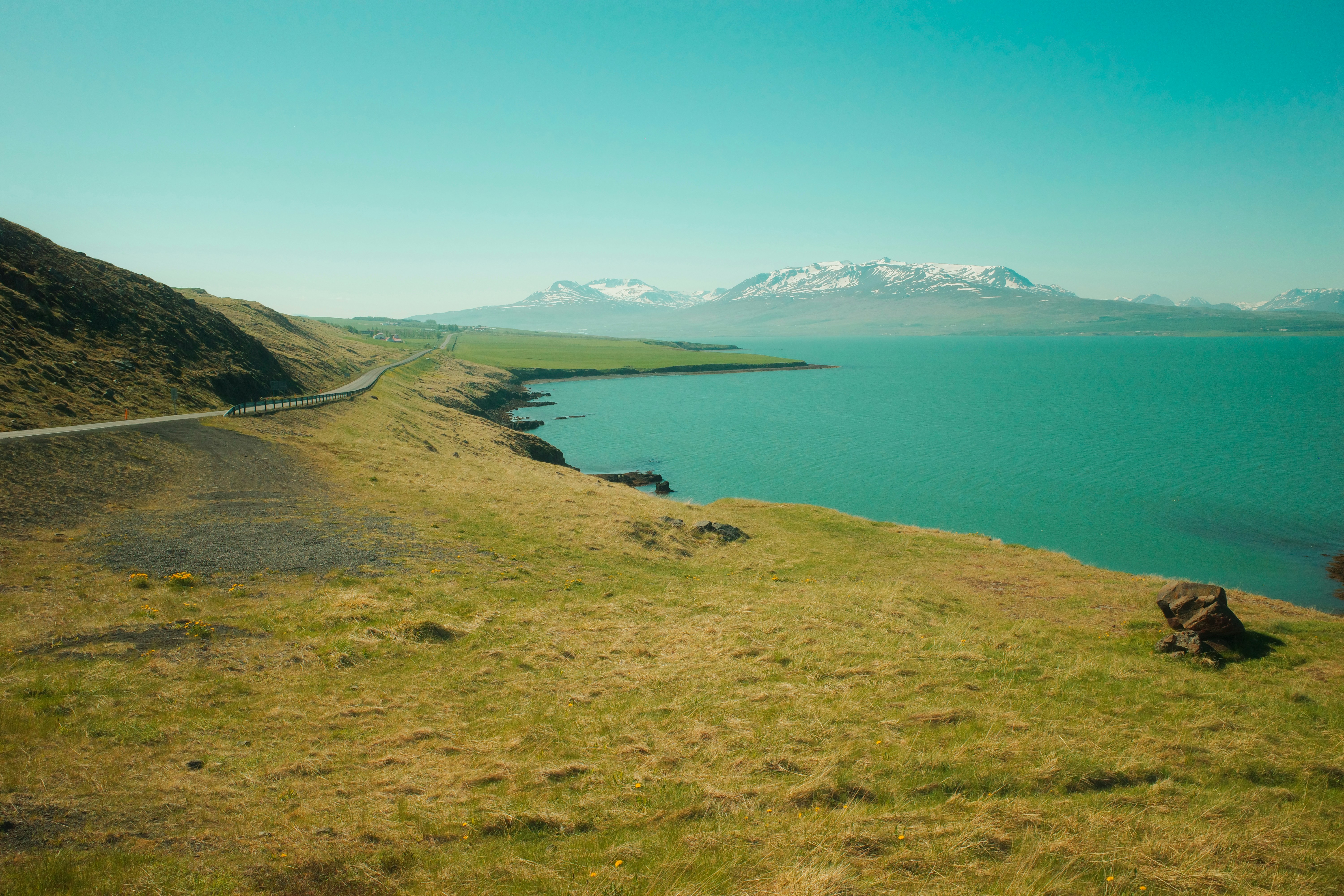 Lone shoreline winding toward distant snow-capped peaks