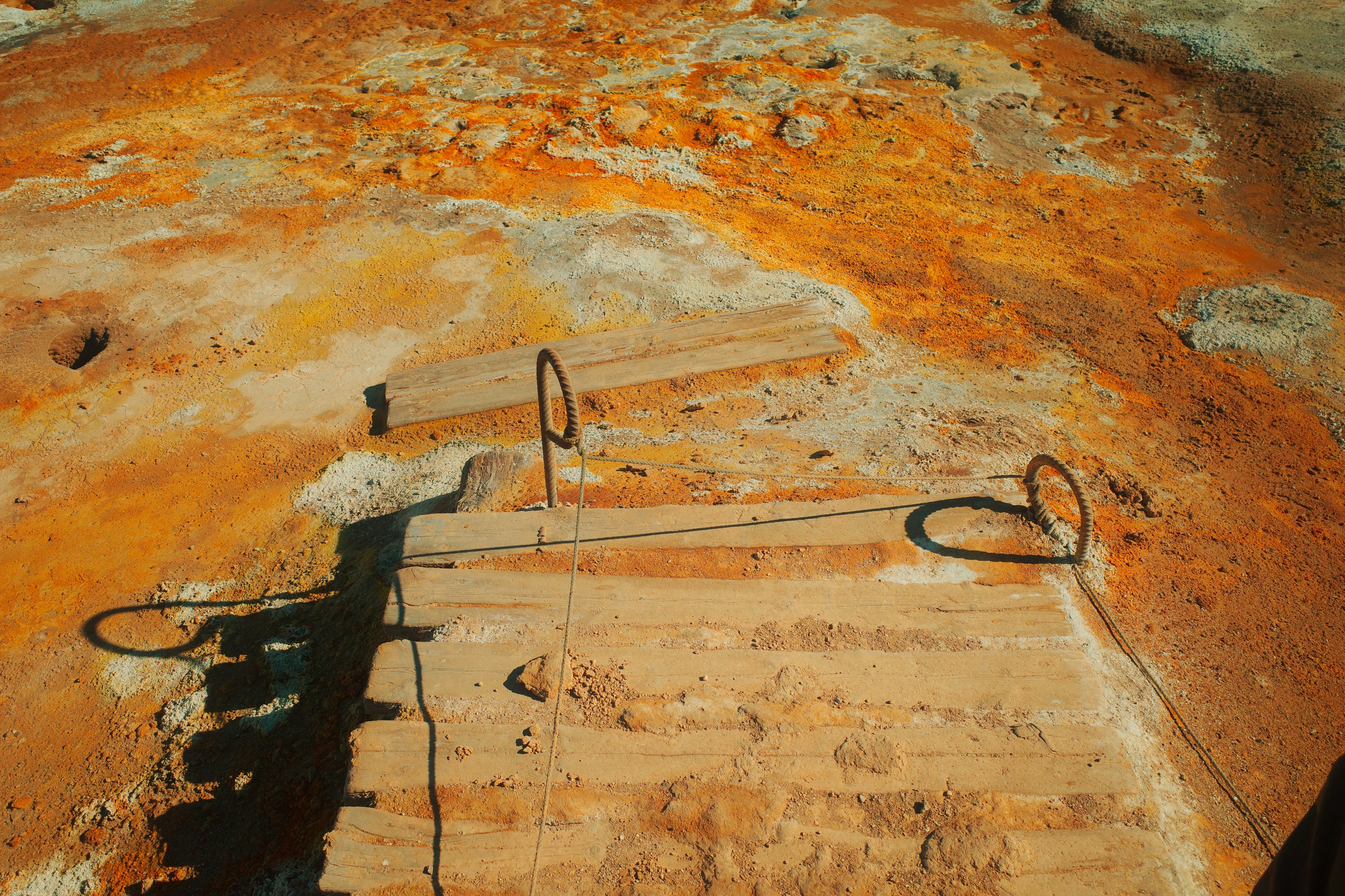 Rust-orange steps into a geothermal landscape