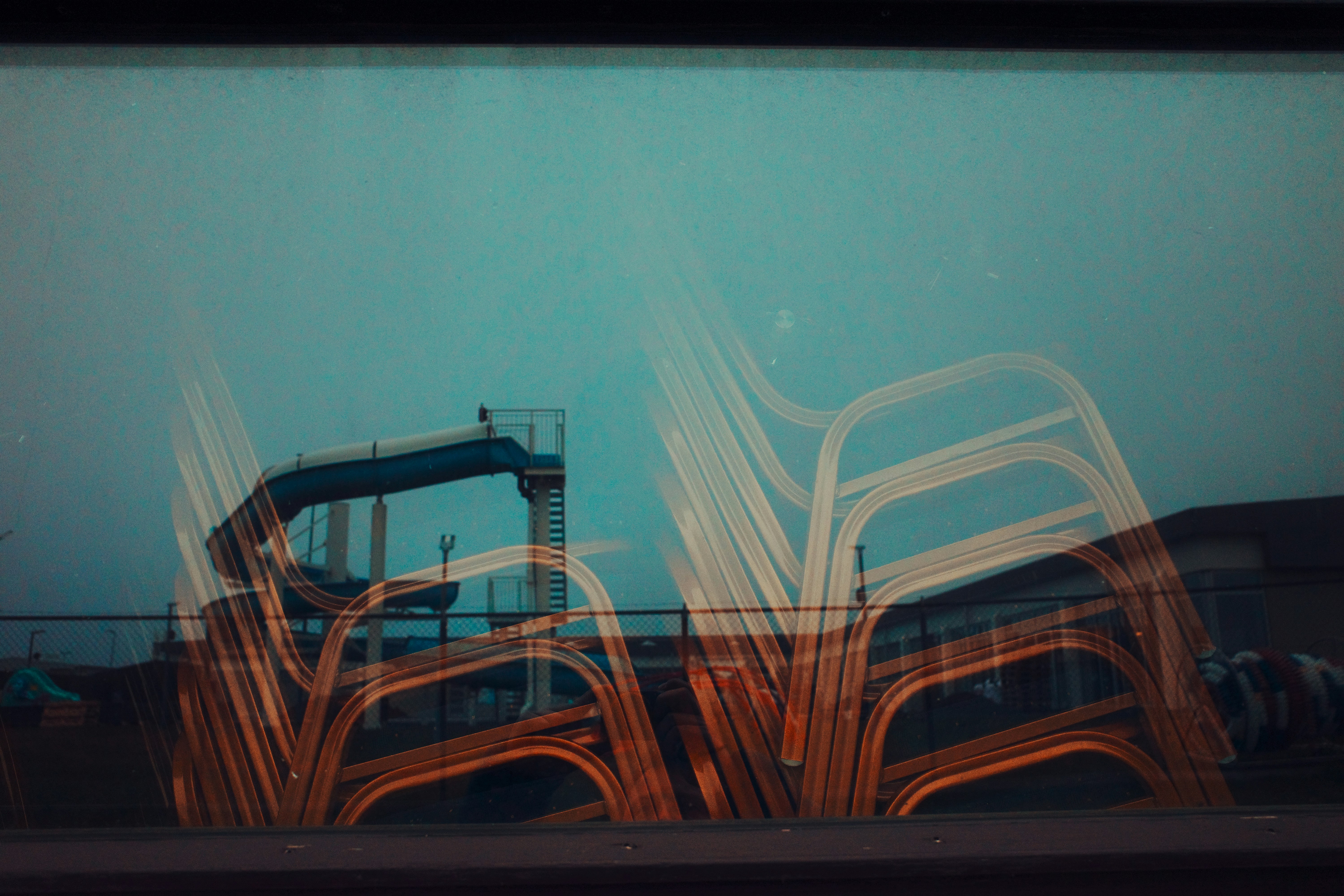 Stacked Echoes: Reflections of Chairs in Transit
