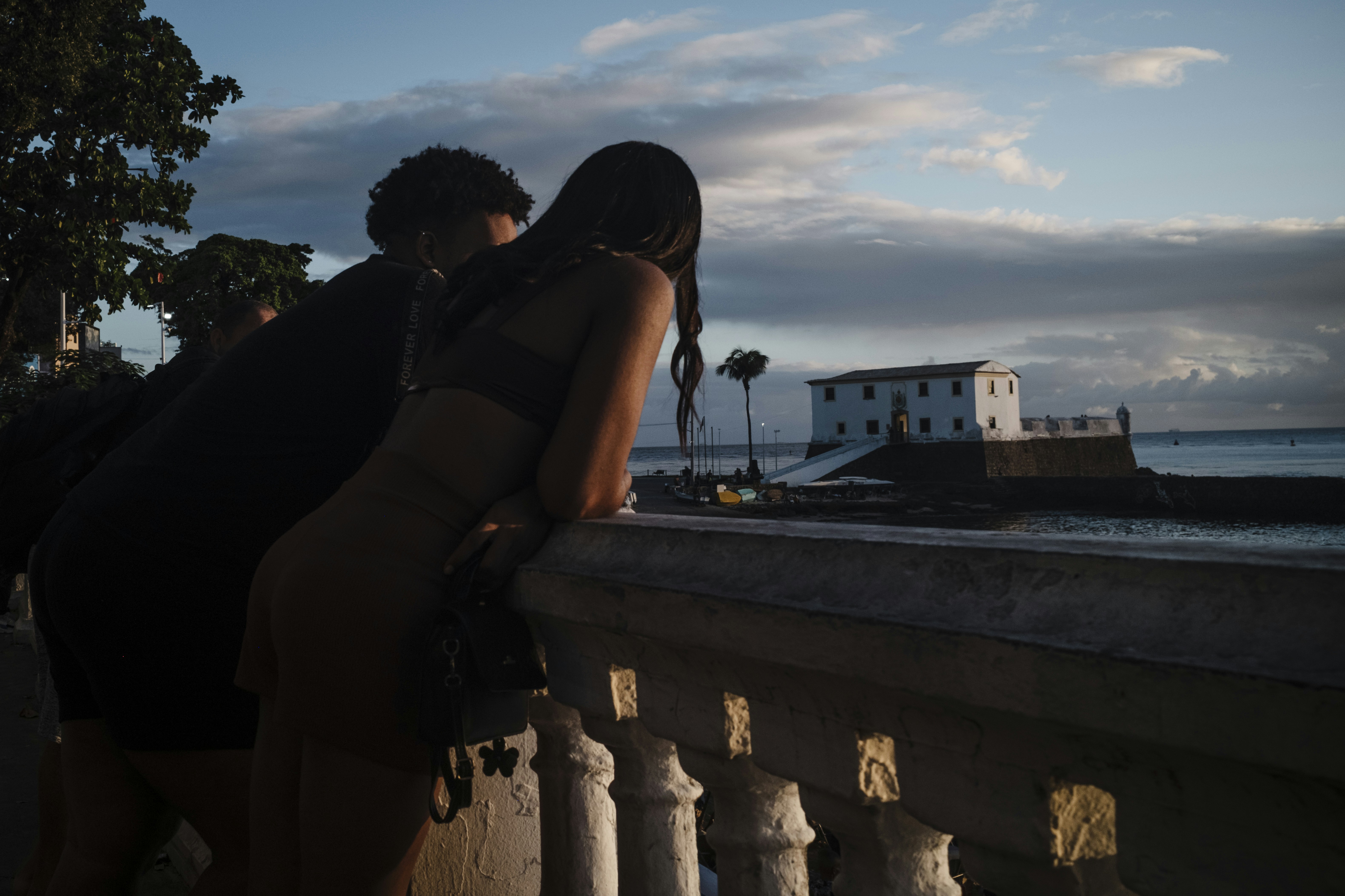 Whispers at the Terrace: Sunset Glance by the Rail