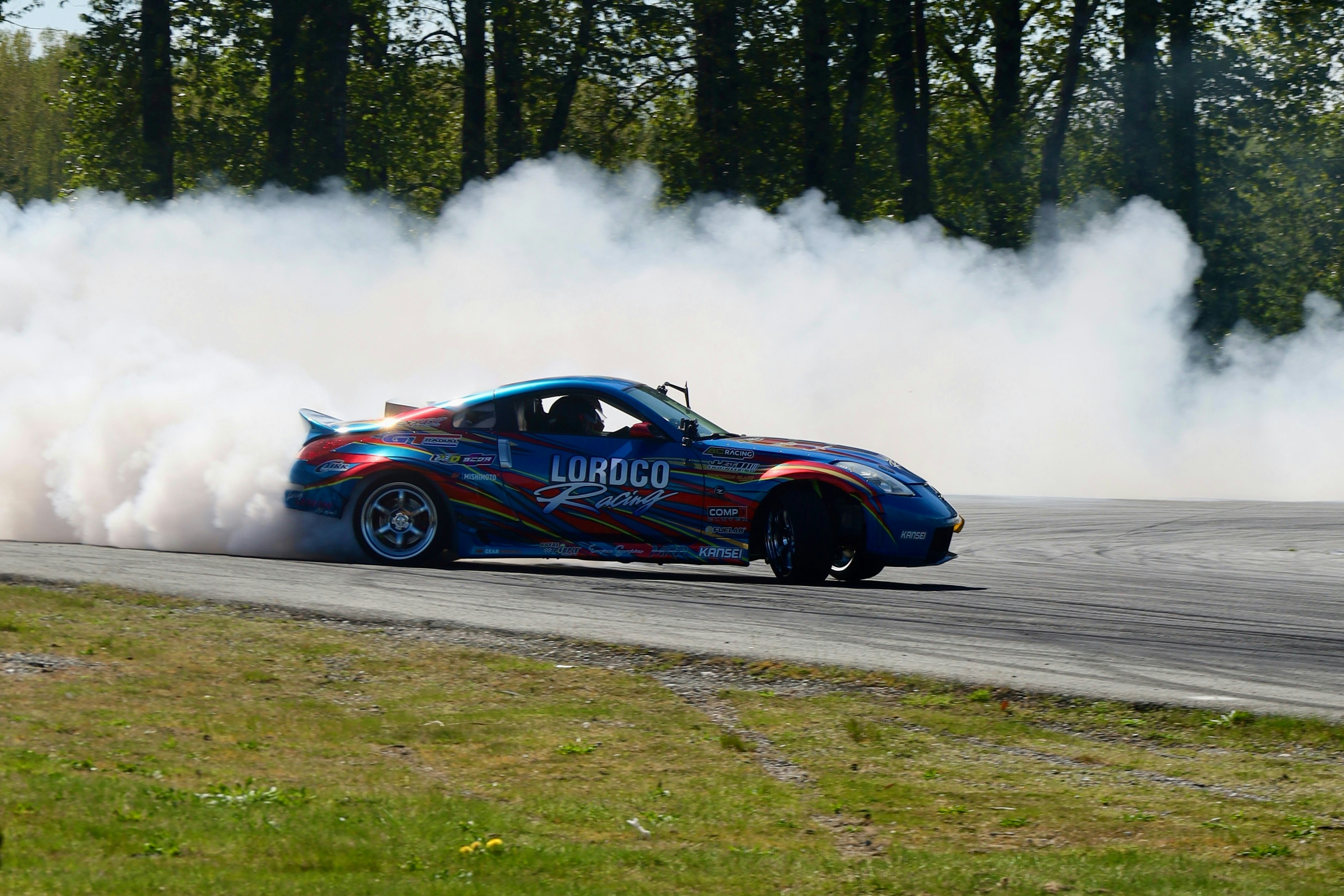 Drift Blaze: a cobalt racer car hunkers into a smoke-kissed corner