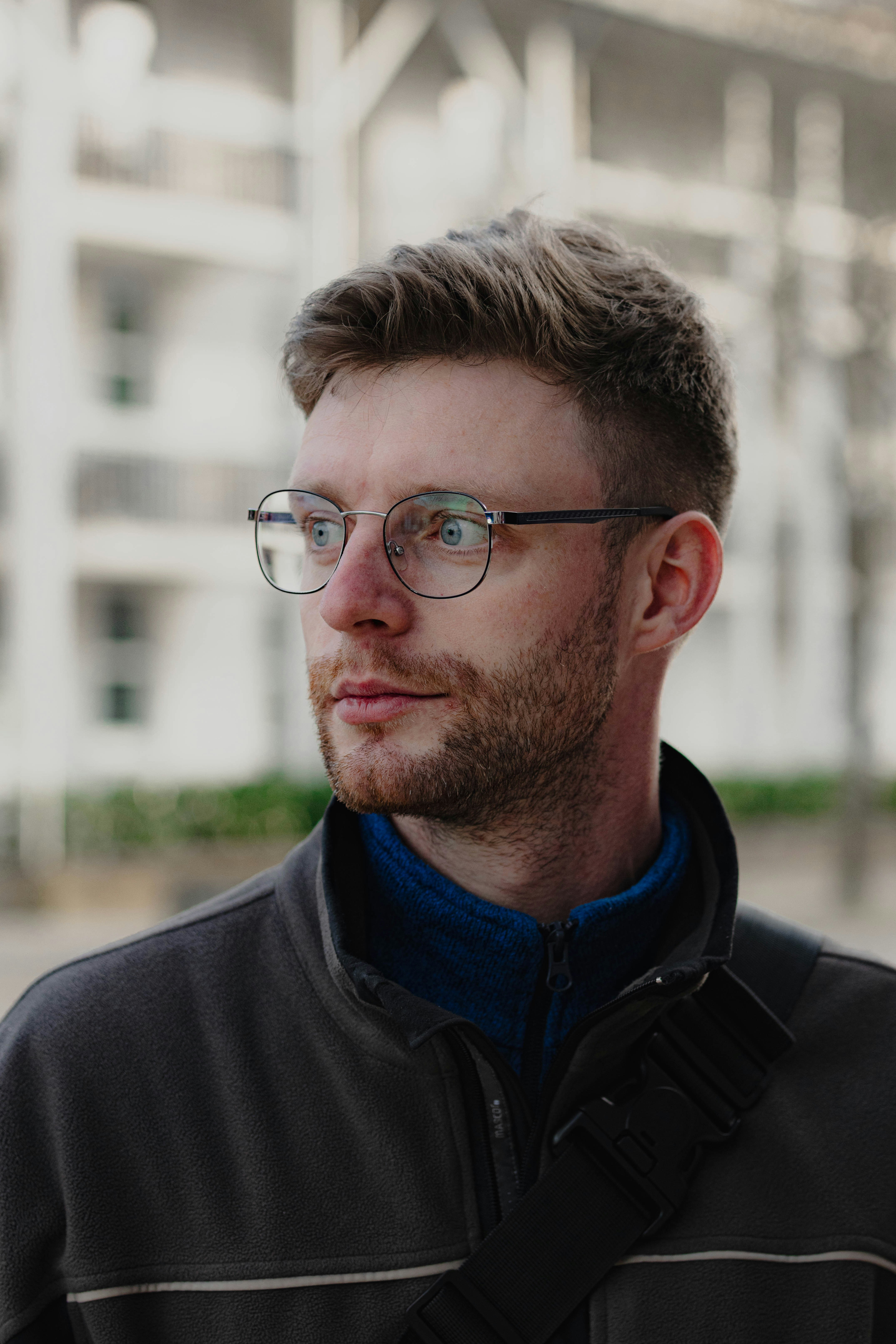Glasses, Gaze, and Urban Light: A Portrait in Quiet Focus