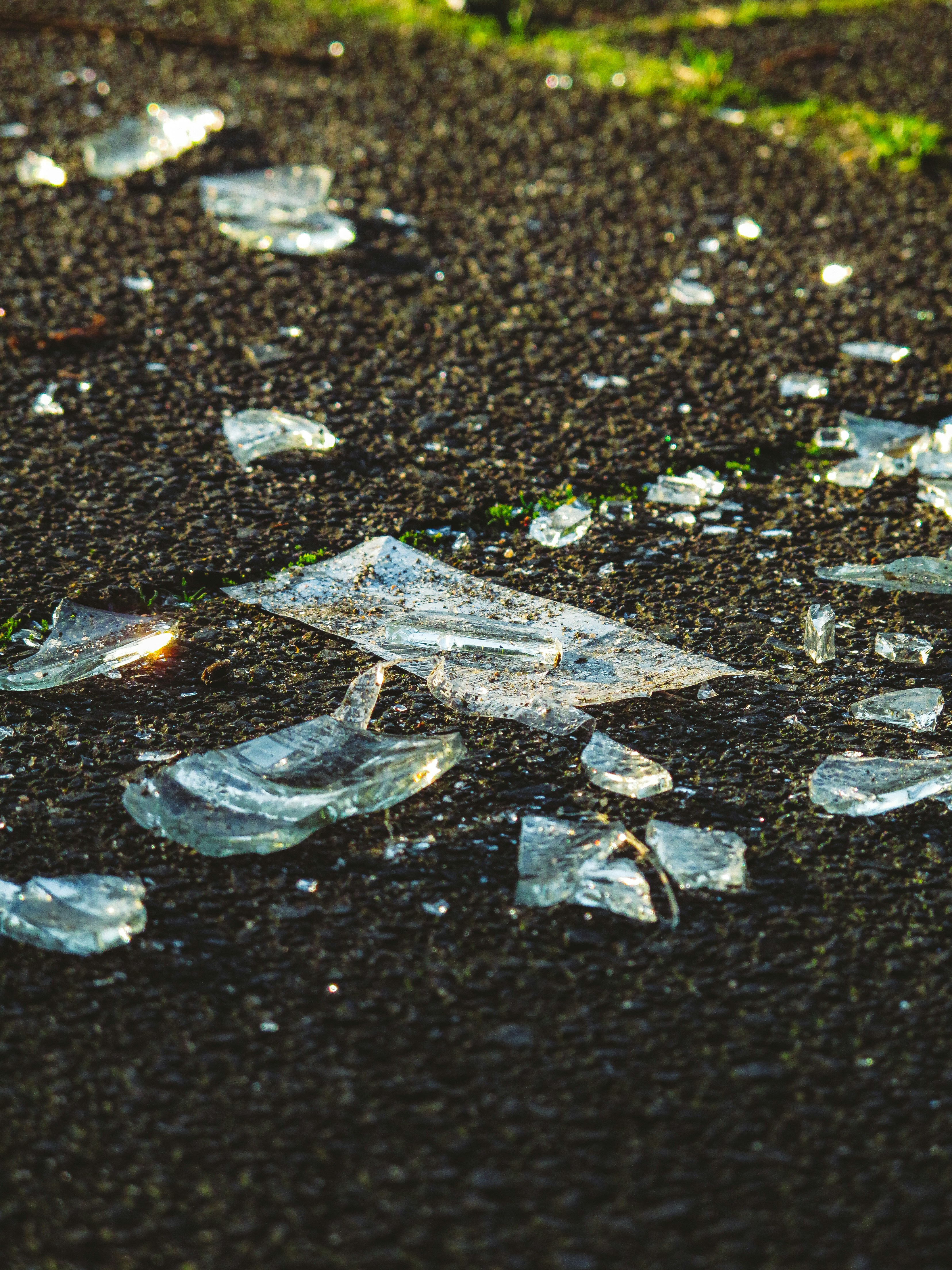 Shattered reflections on a sunlit pavement
