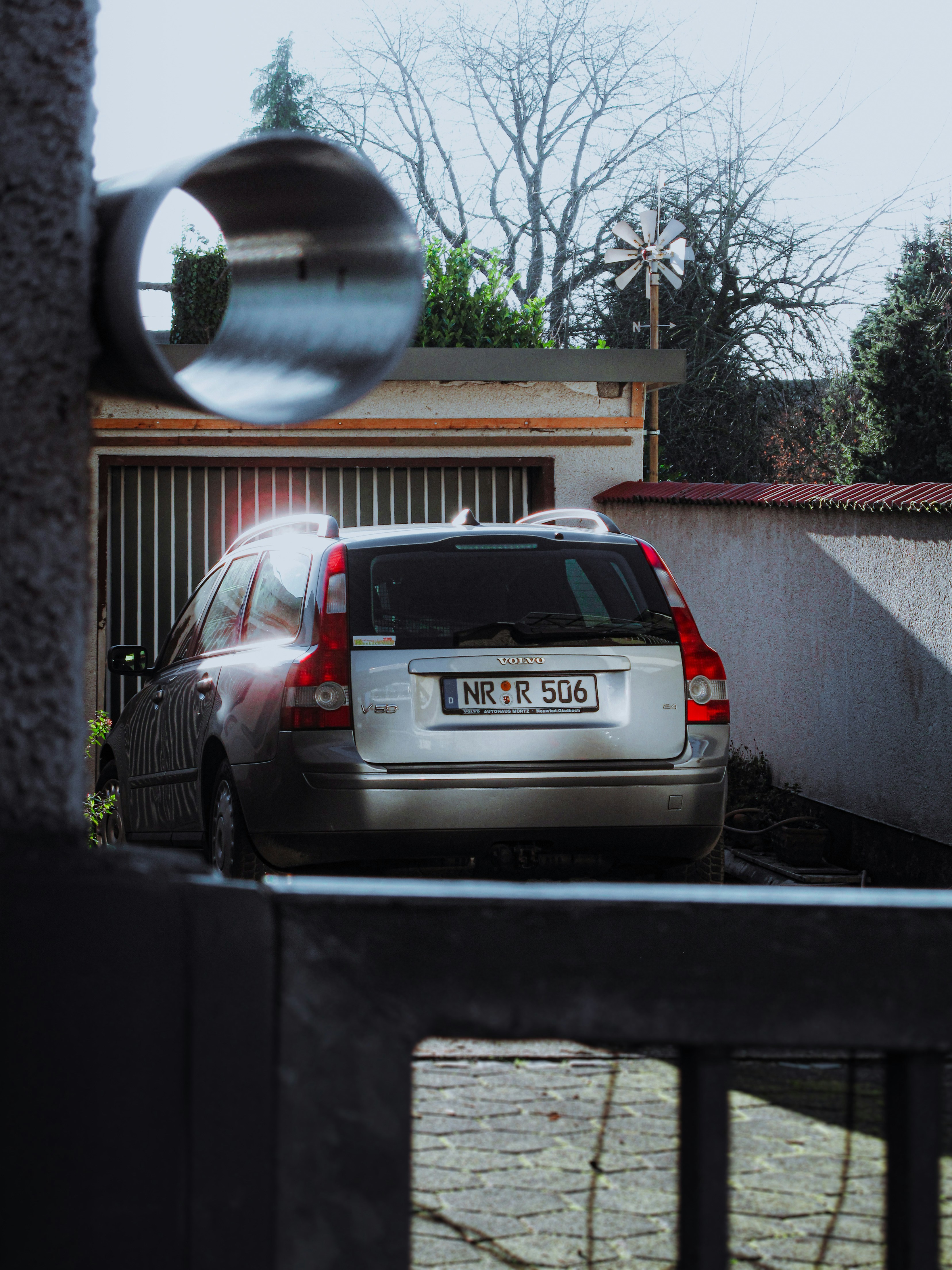 Backyard Driveway Reveal: Silver Volvo B58 Under a Narrow Canopy