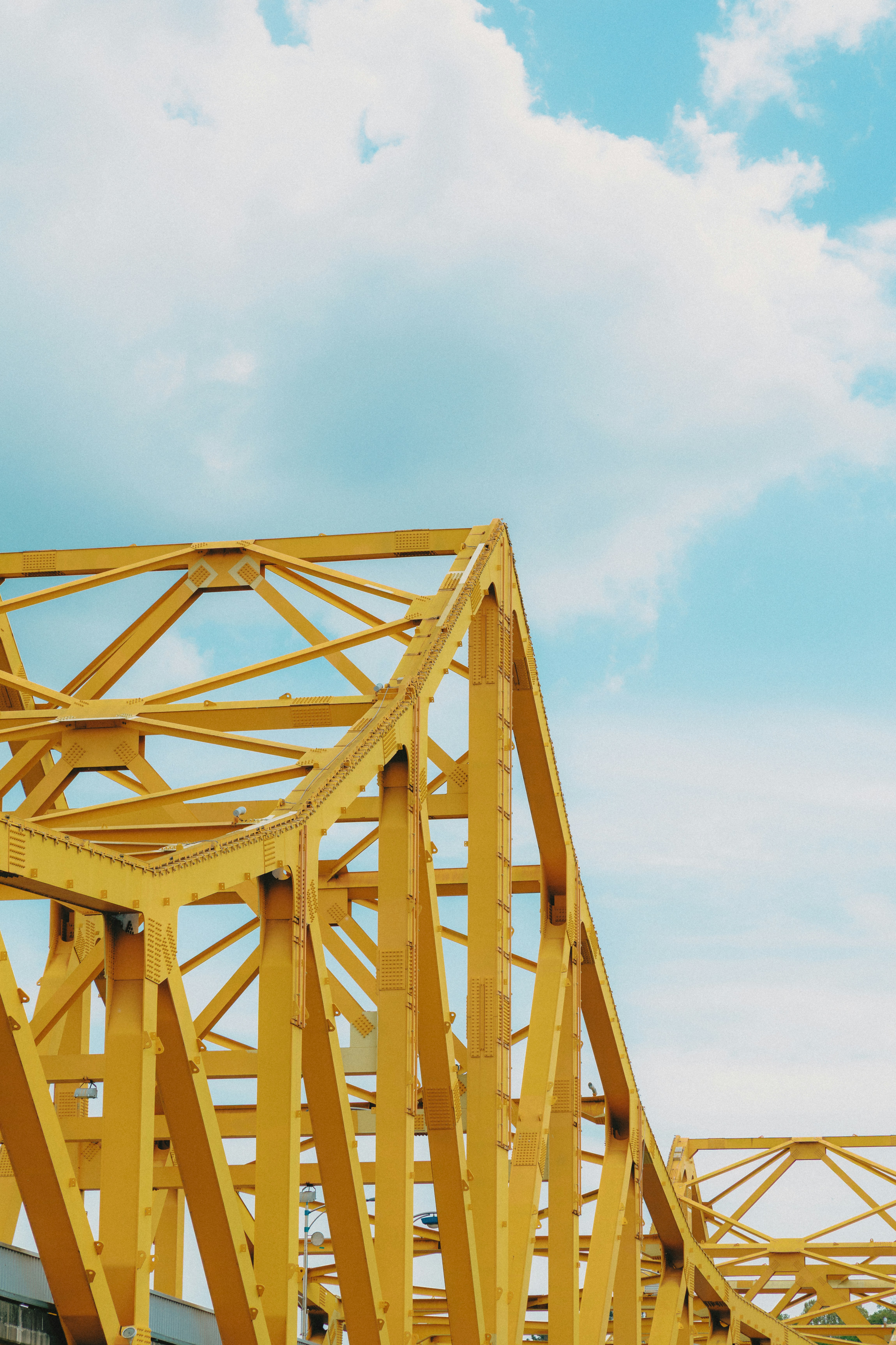 Golden Lattice: Steel Arches Rising into a Bright Sky