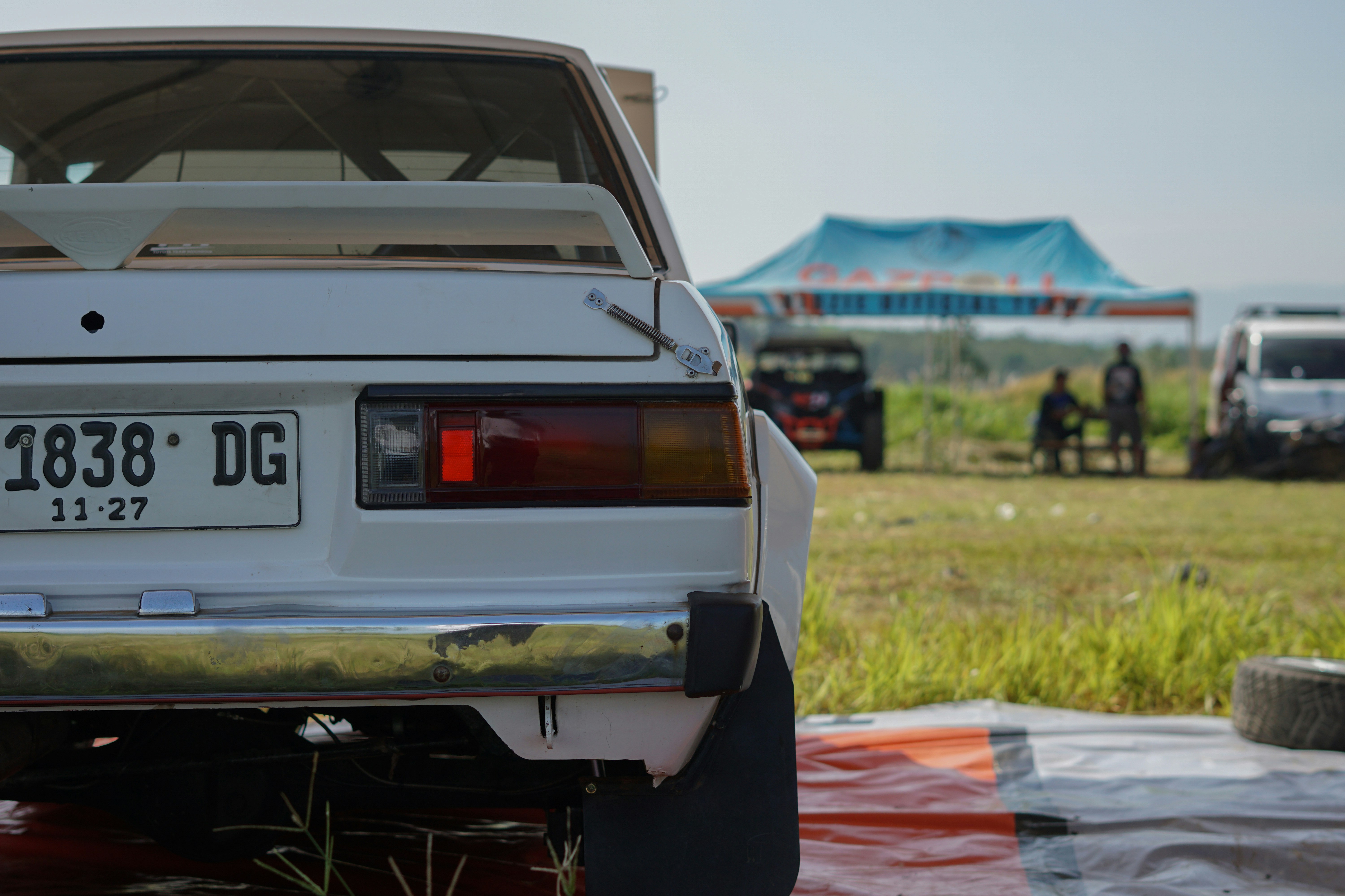 Rear-View Focus: Classic Car at a Grass-Run Race Course