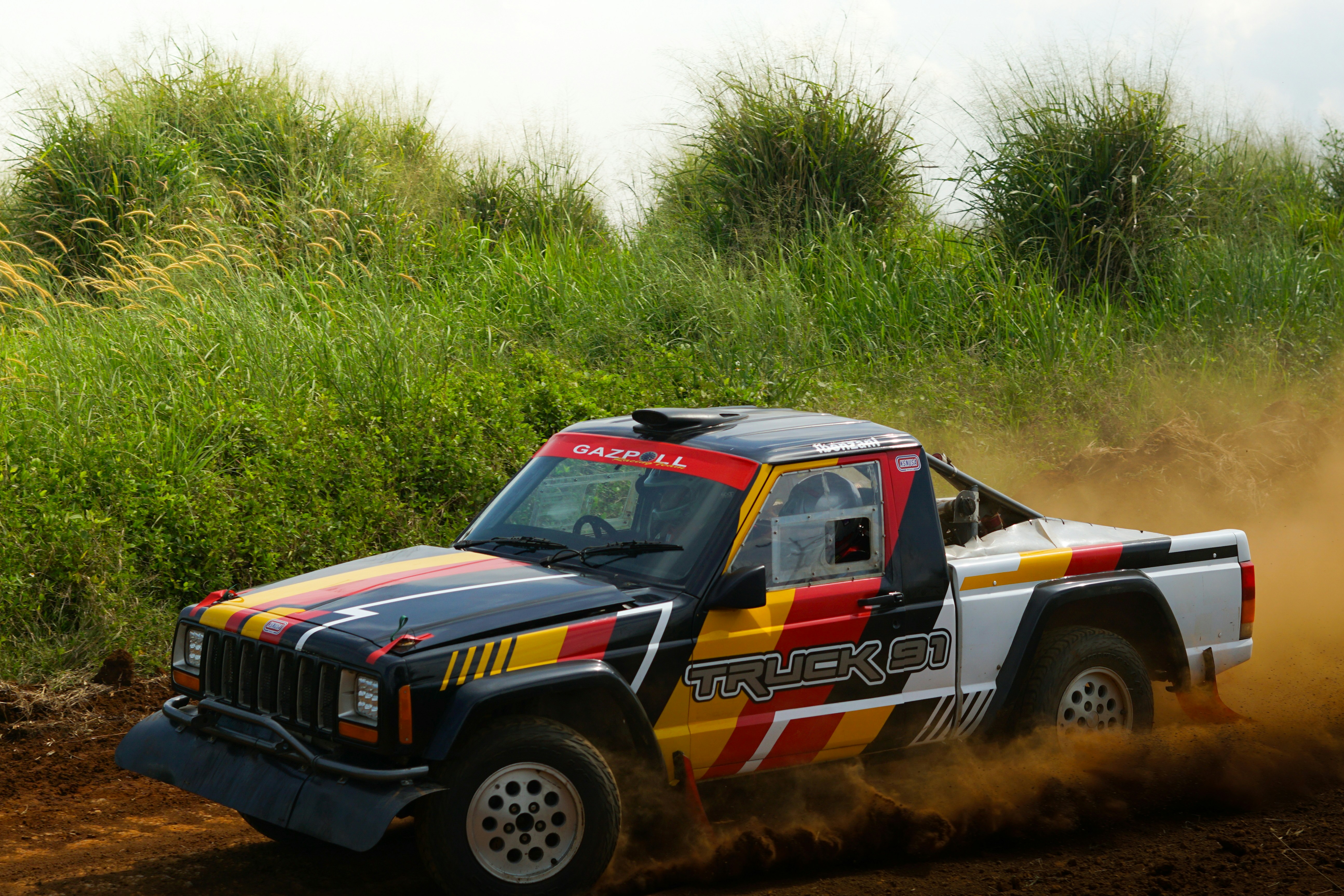 Dusty Victory: A Colored Off-Road Truck Punches Through the Grit