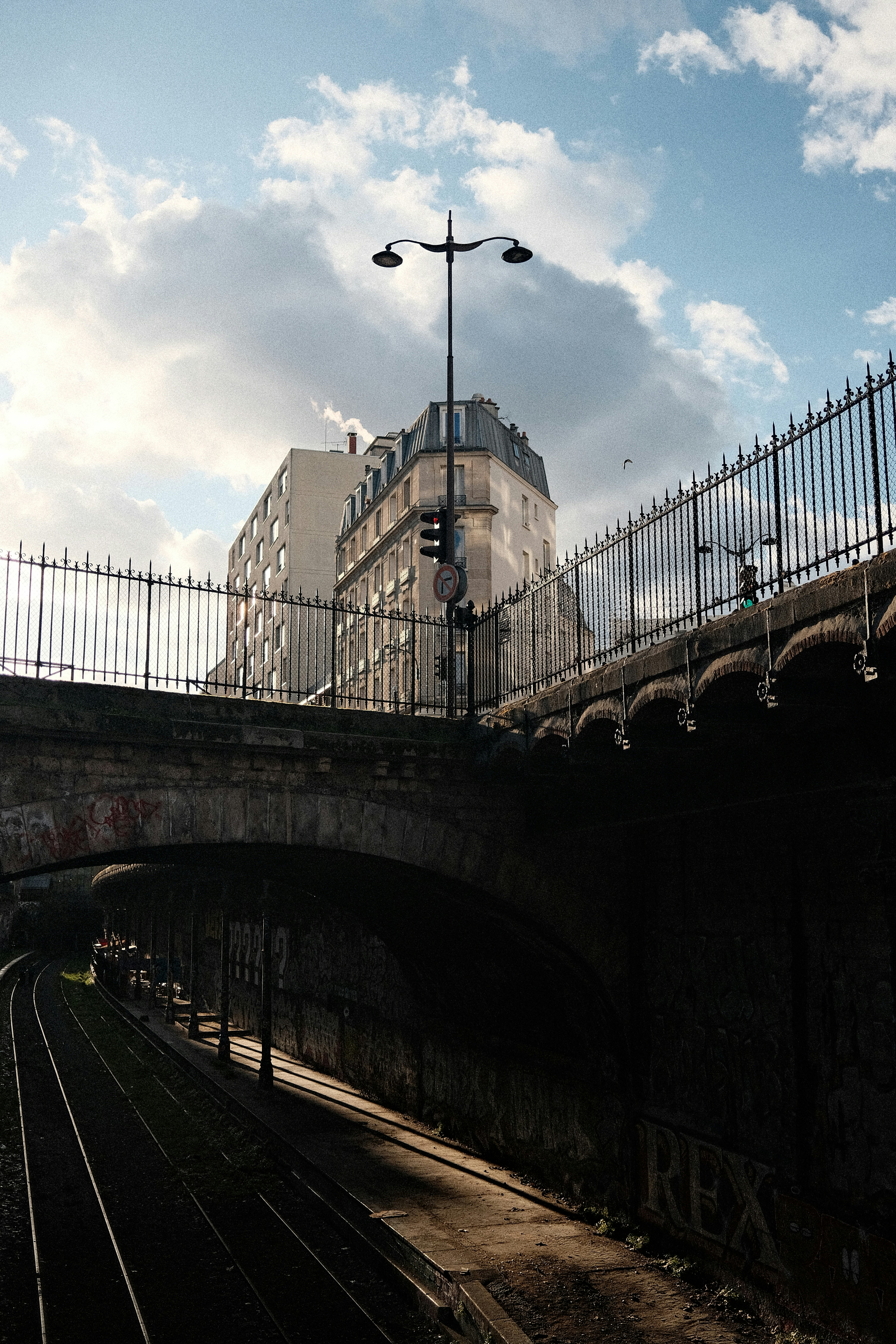 Bridge Over Rails at Dusk: City Line and Ironwork