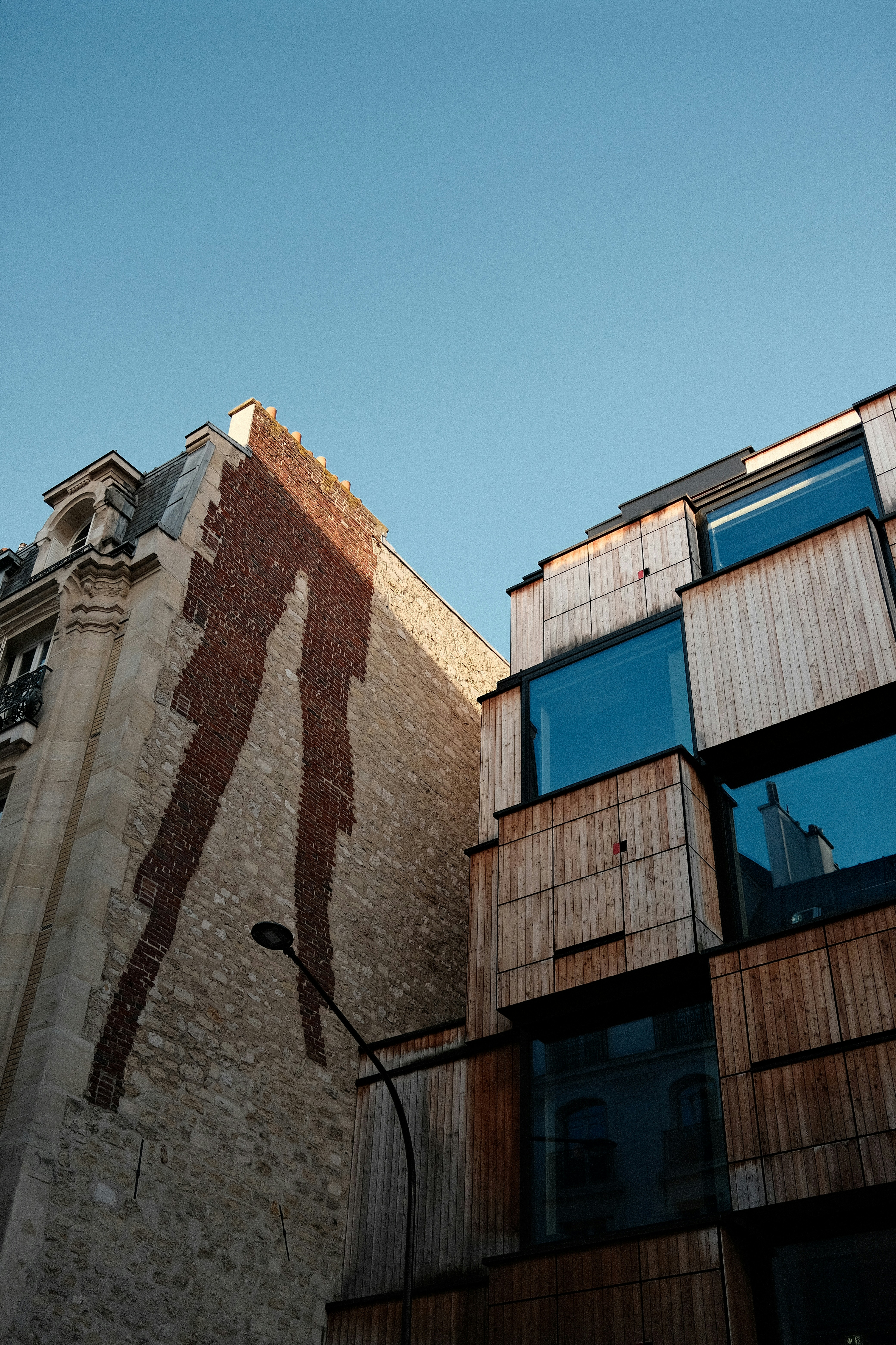 Urban Facades Converge: Brick and Glass at Dusk