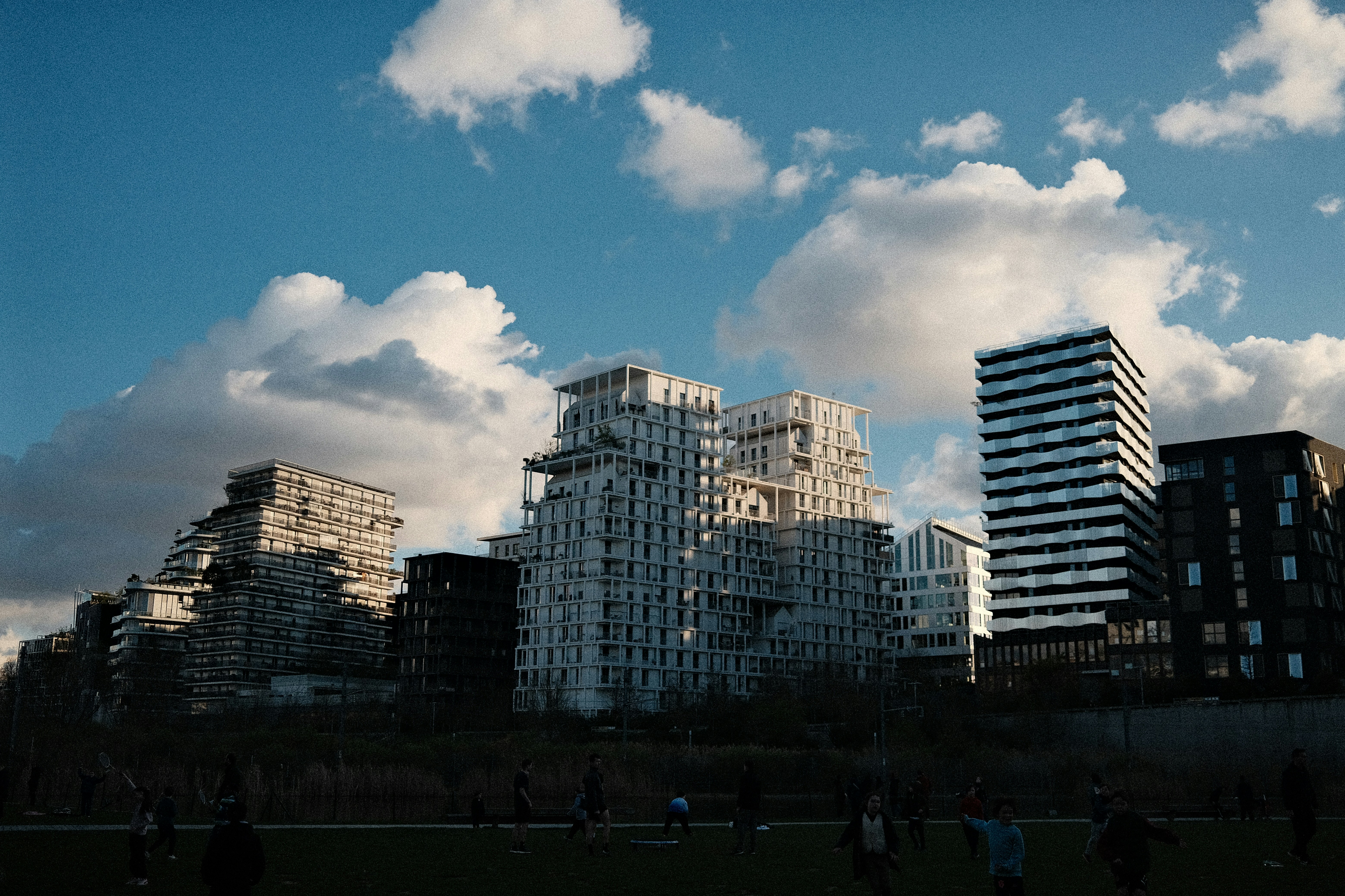 Sunlit Glass Towers Rising Over a Quiet Park