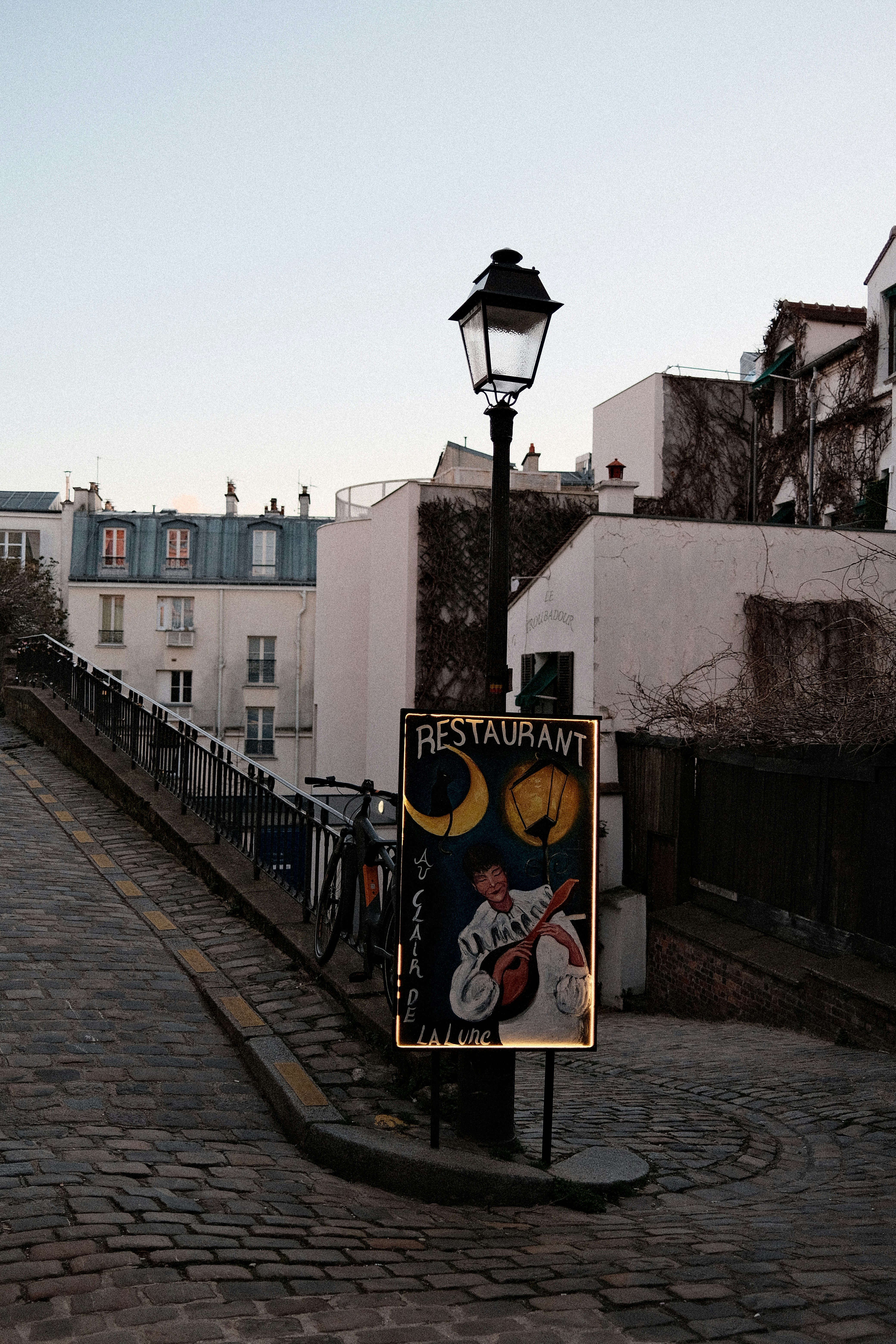 Moonlit Signboard, Cobblestones, and Streetlamp: A Parisian Quiet