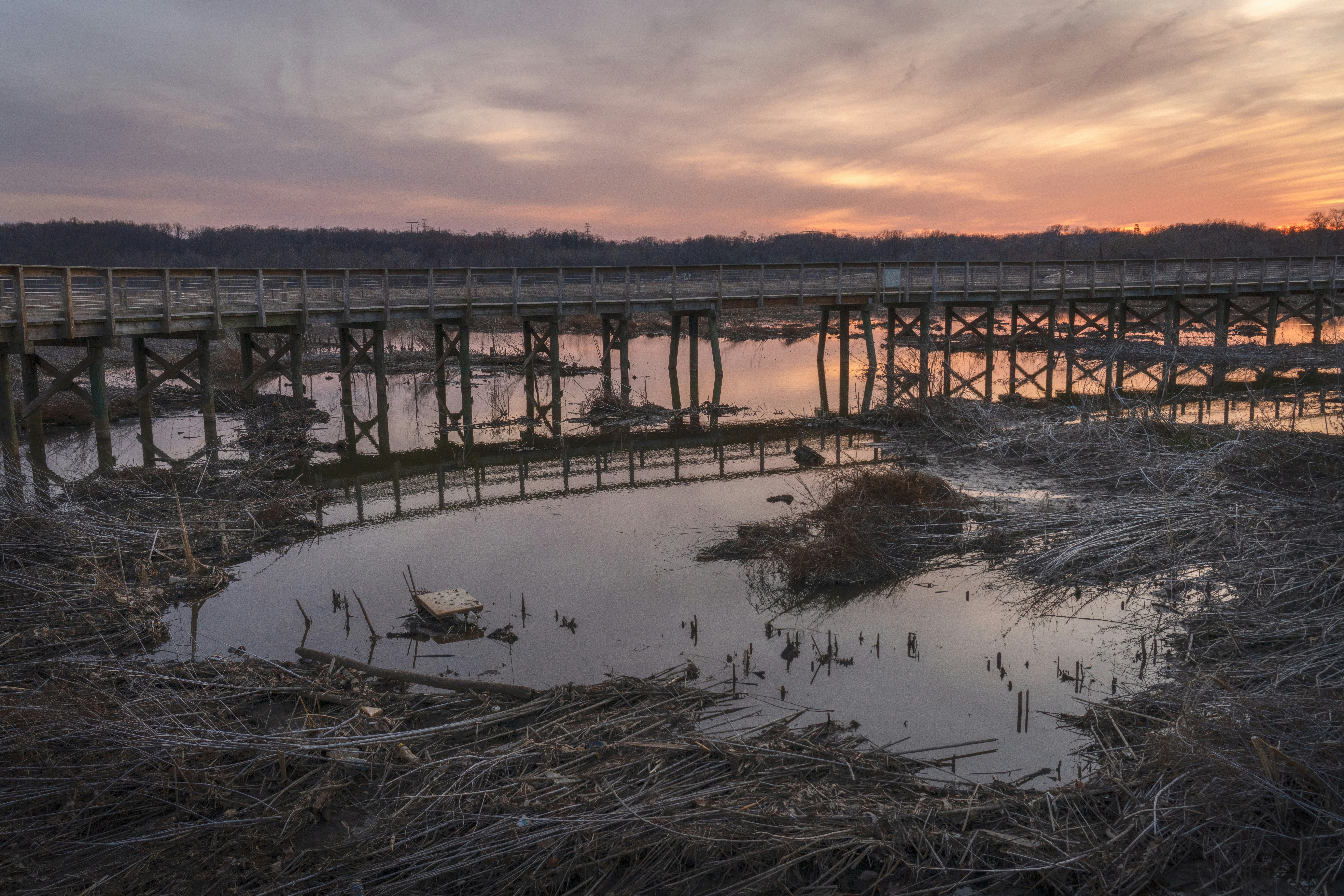 Sunset Over a Weathered Pier: Echoes on the Tidal Flats