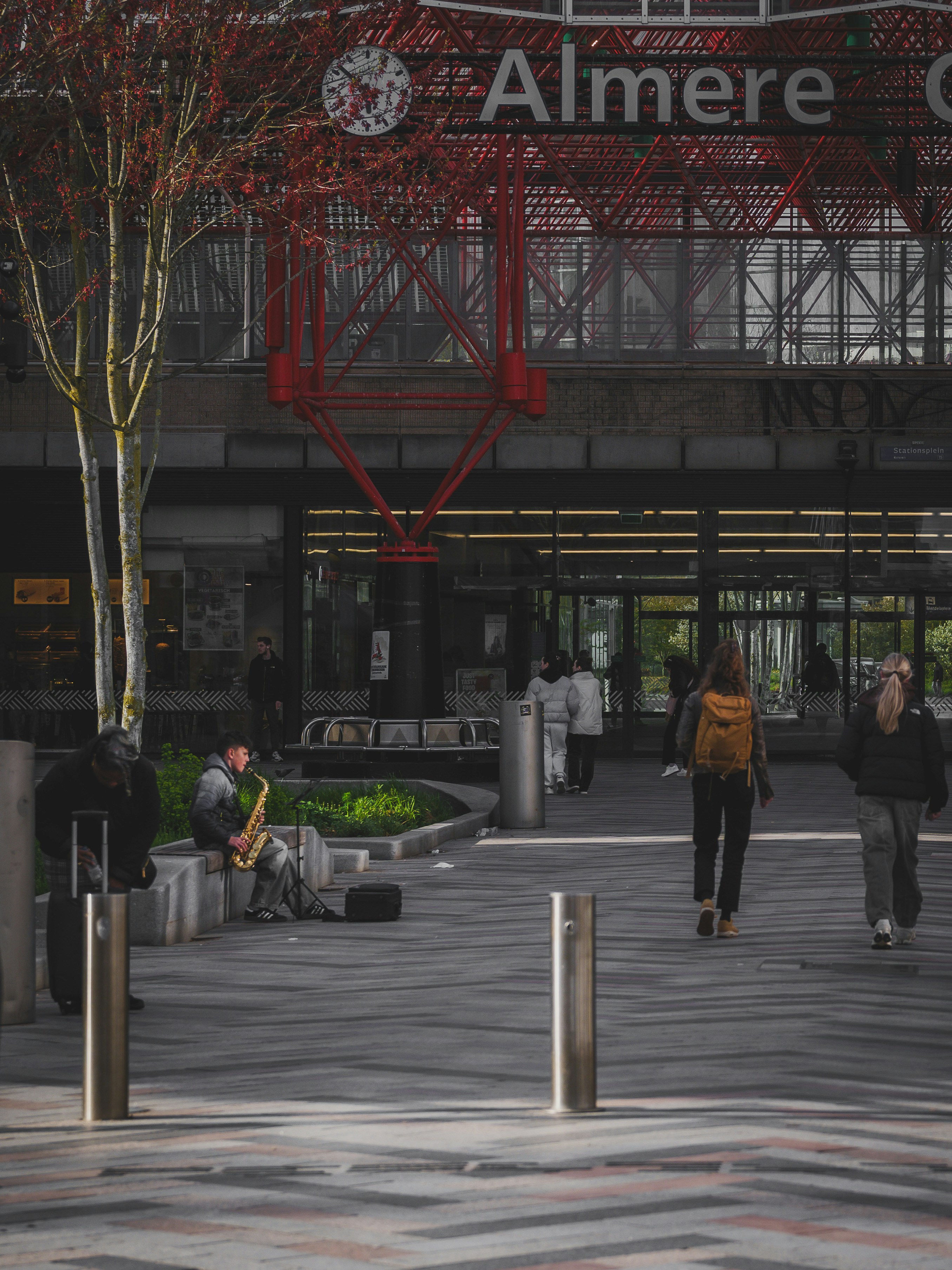 Urban Saxophone at Dusk: A Quiet Moment Outside Almere Gate