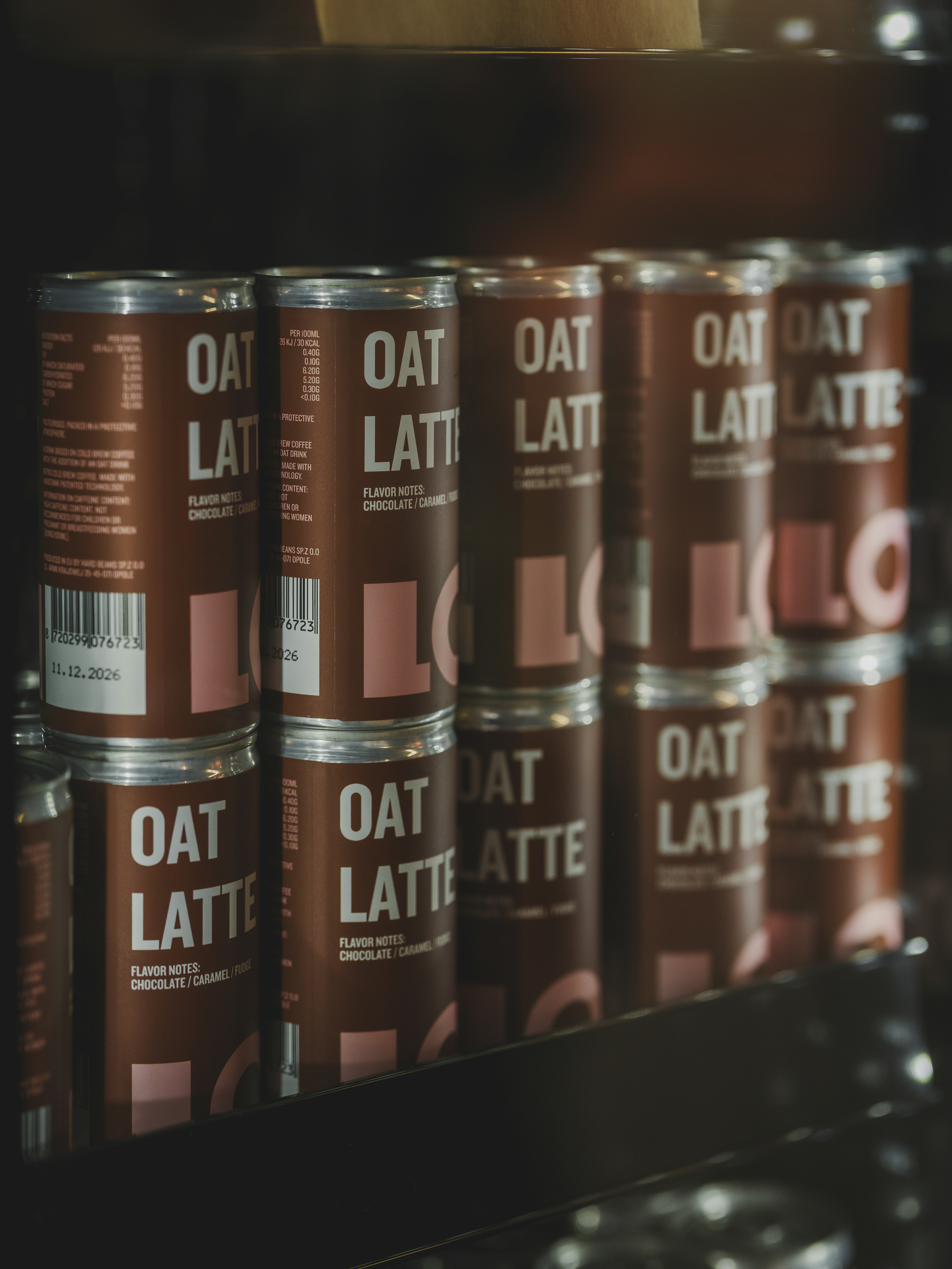 Rows of Chocolatey Oat Latte Cans—Soft Focus Shelf Portrait