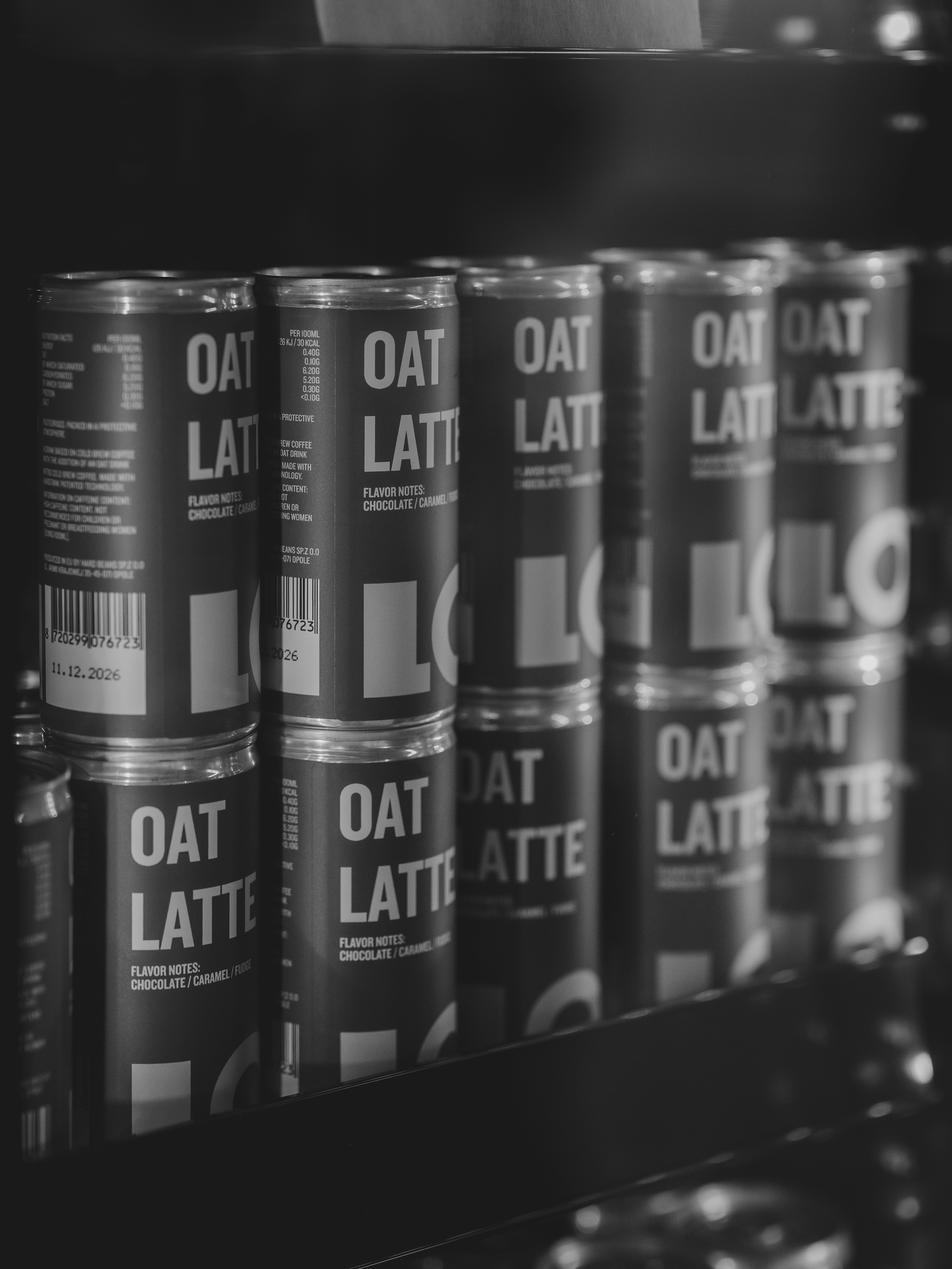 Rows of Oat Latte Cans: Quiet Shelf in Monochrome