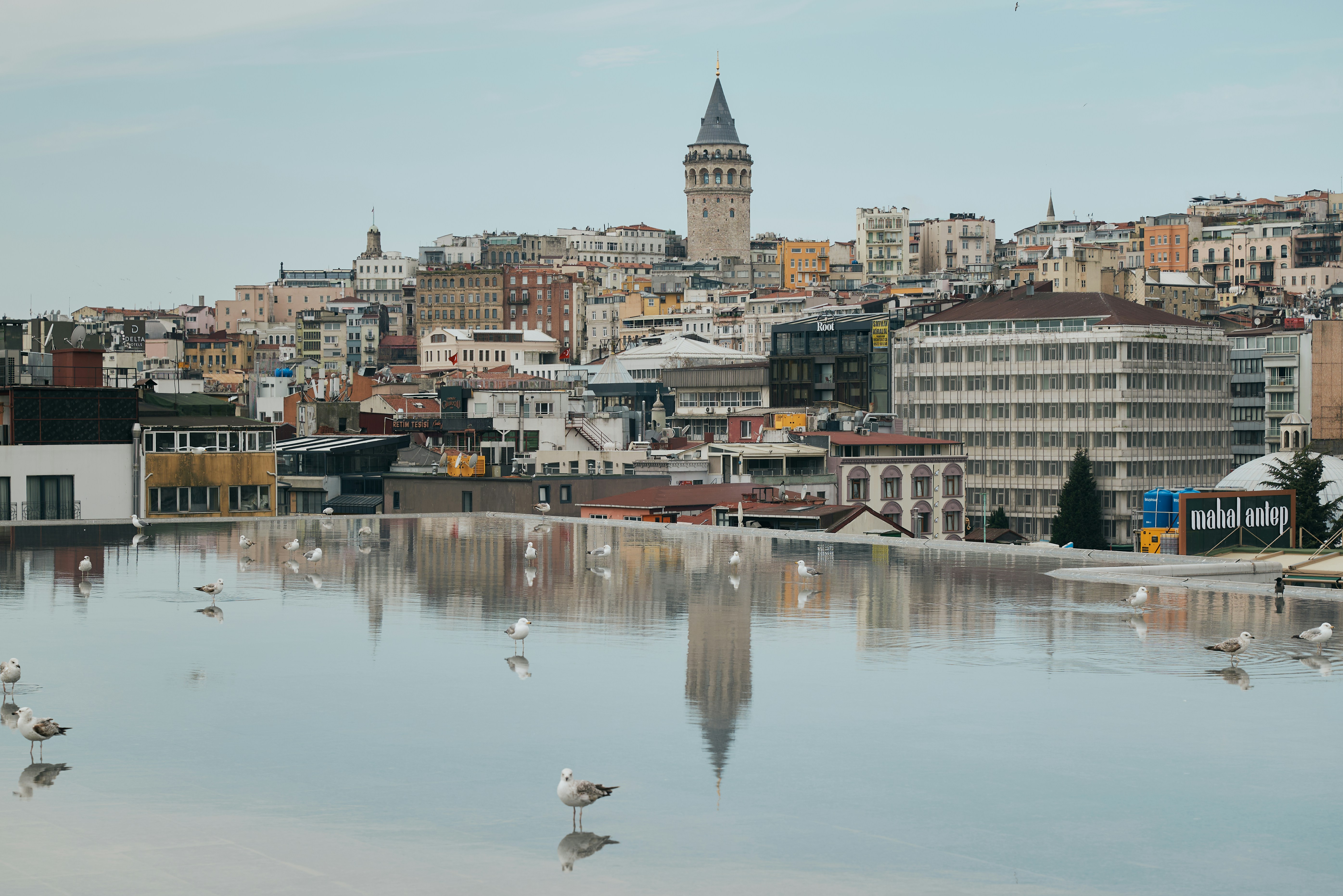 Turreted skyline over a reflective harbor