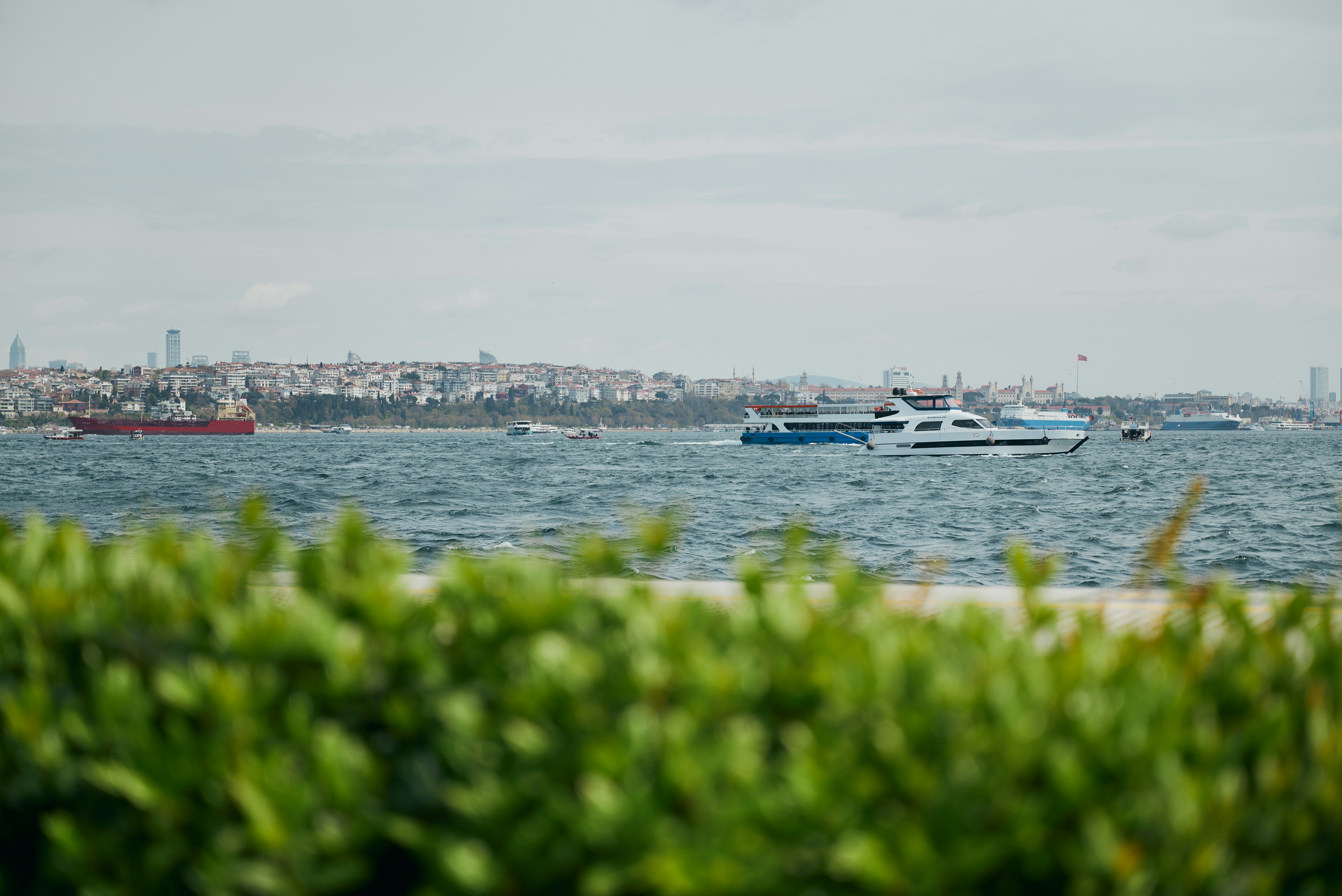 Coastal Transit: A Fleet of Boats Traversing Calm Waters