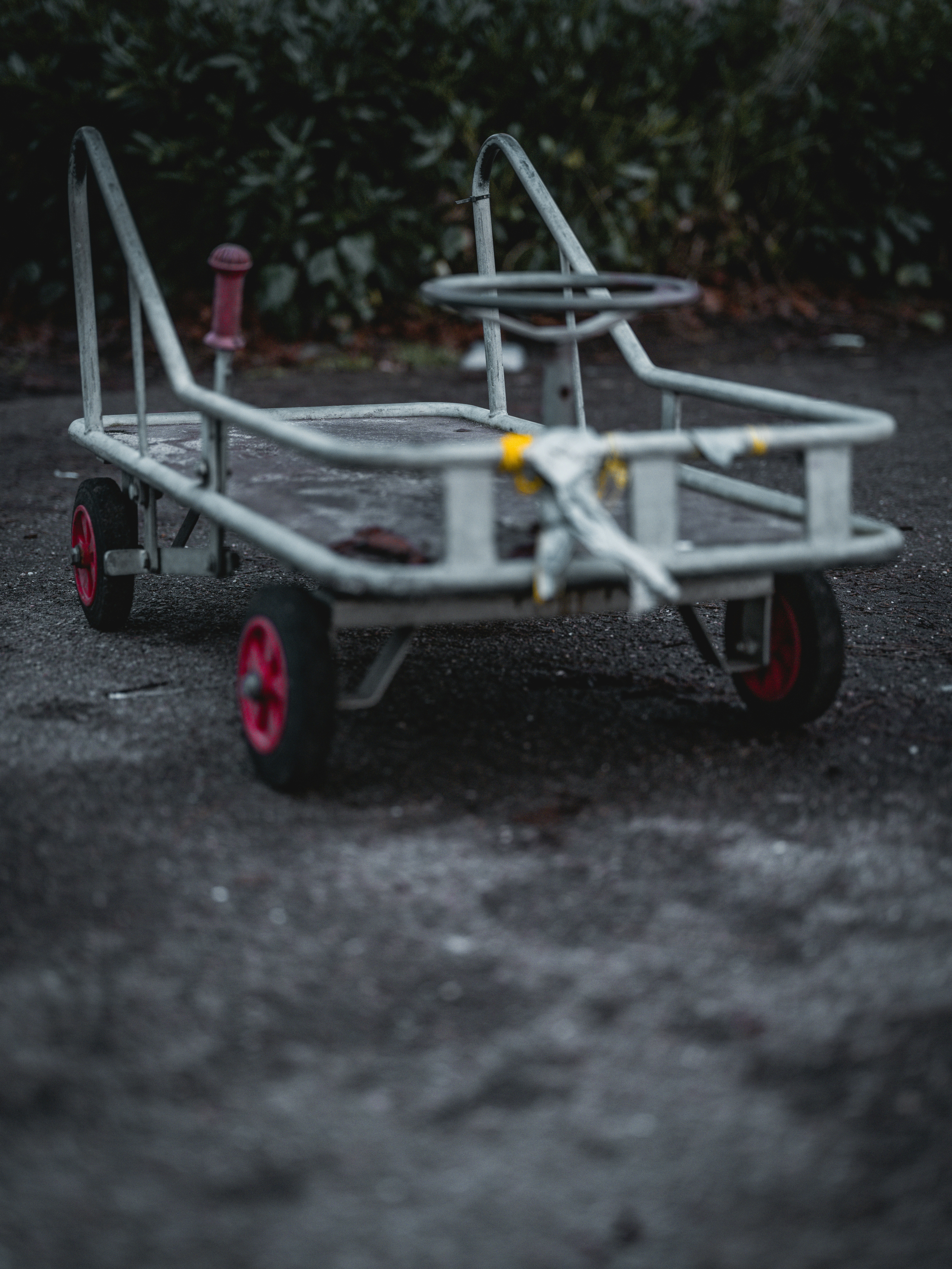 Dusty Playground Cart: A Quiet, Weathered Wagon on a Rough Track