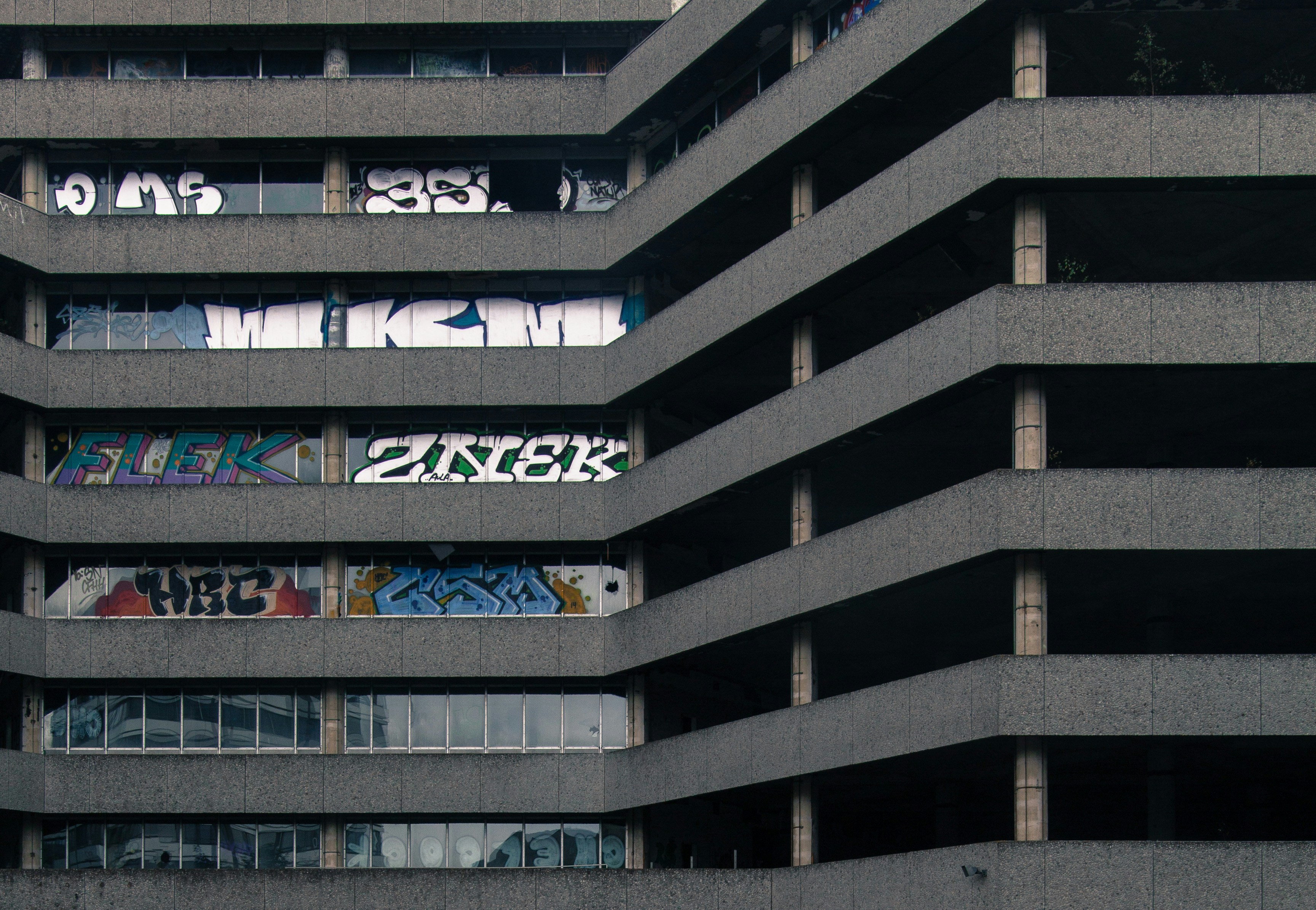 Concrete Echoes: Graffiti Screens in a Louvered Facade