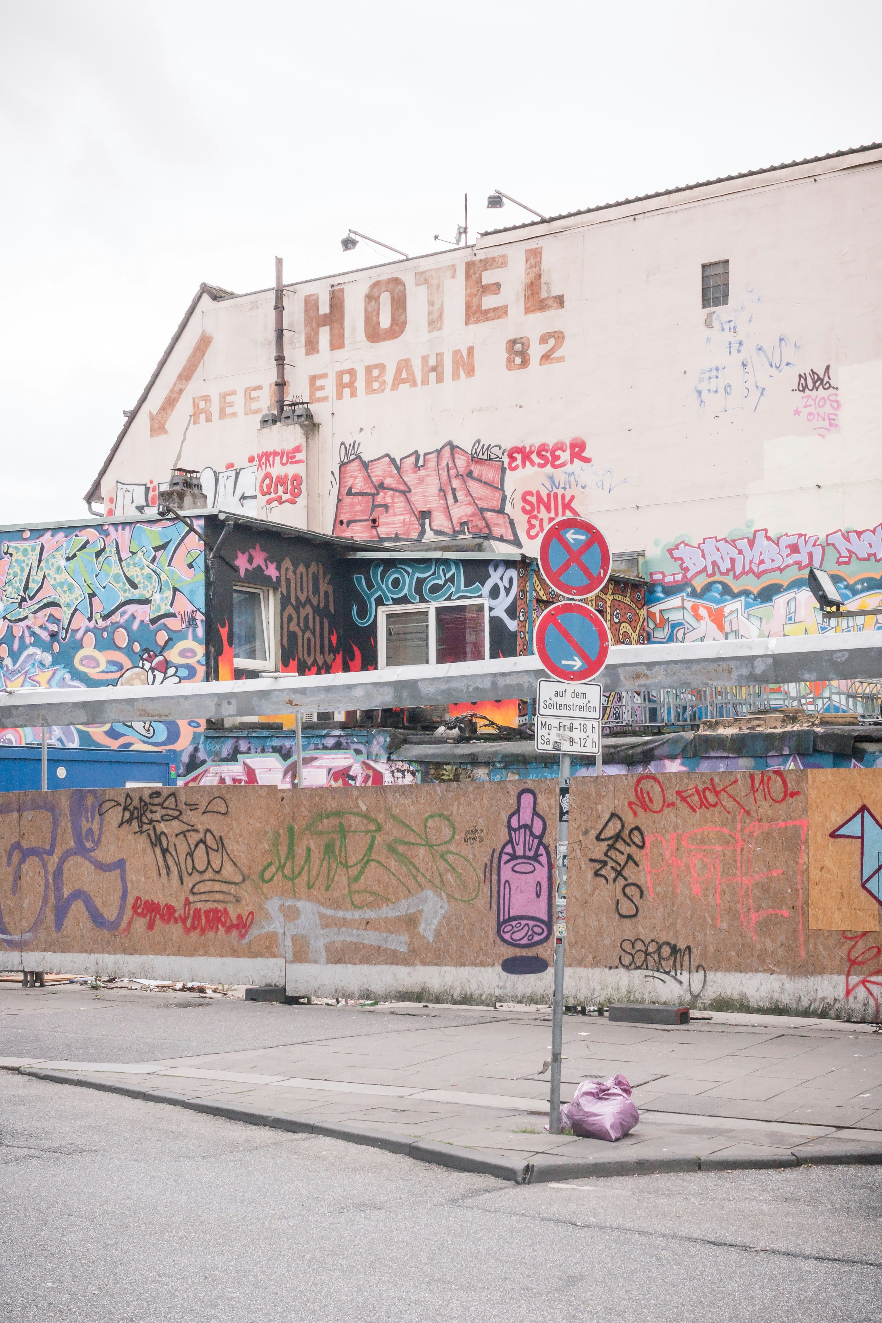 Graffiti-Soaked Hotel Façade: A City Portrait in Color and Concrete