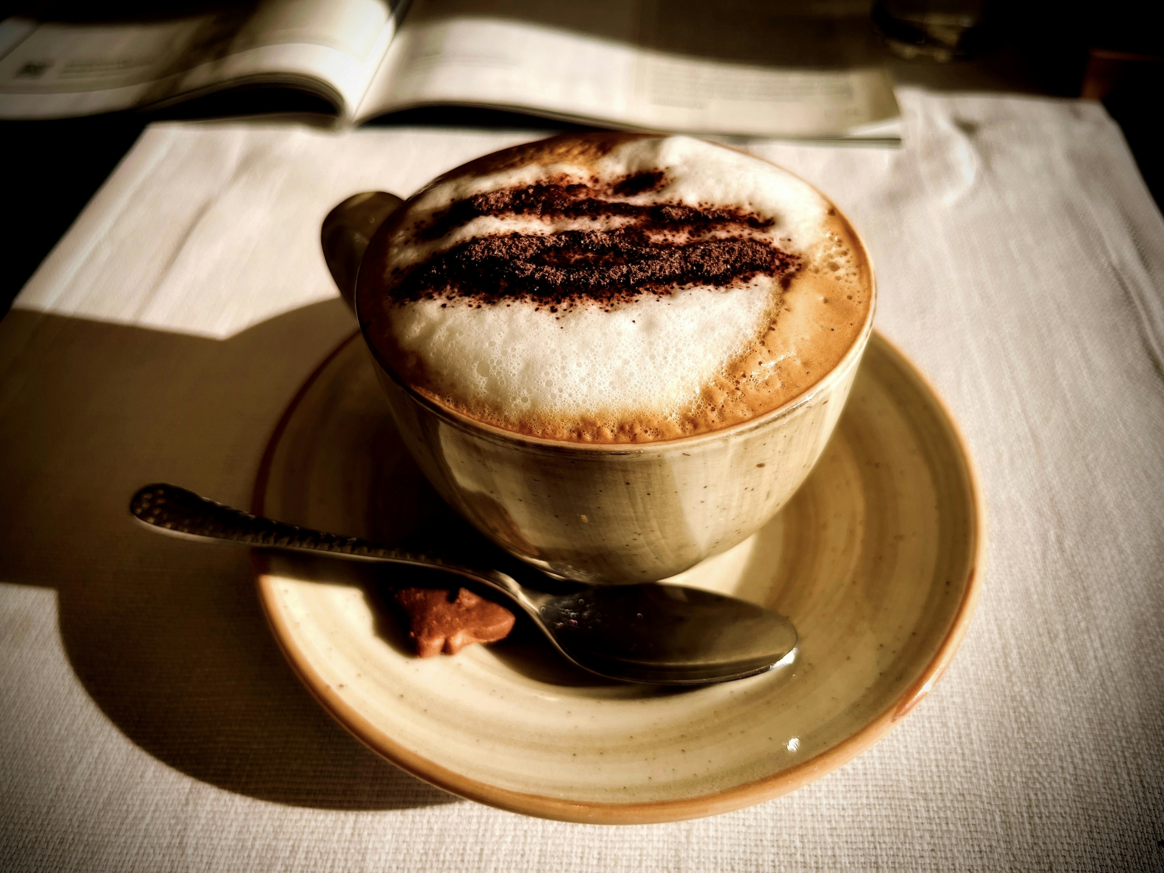 Foamy Heartbeat: A Cappuccino Resting on Creamy Studio Light
